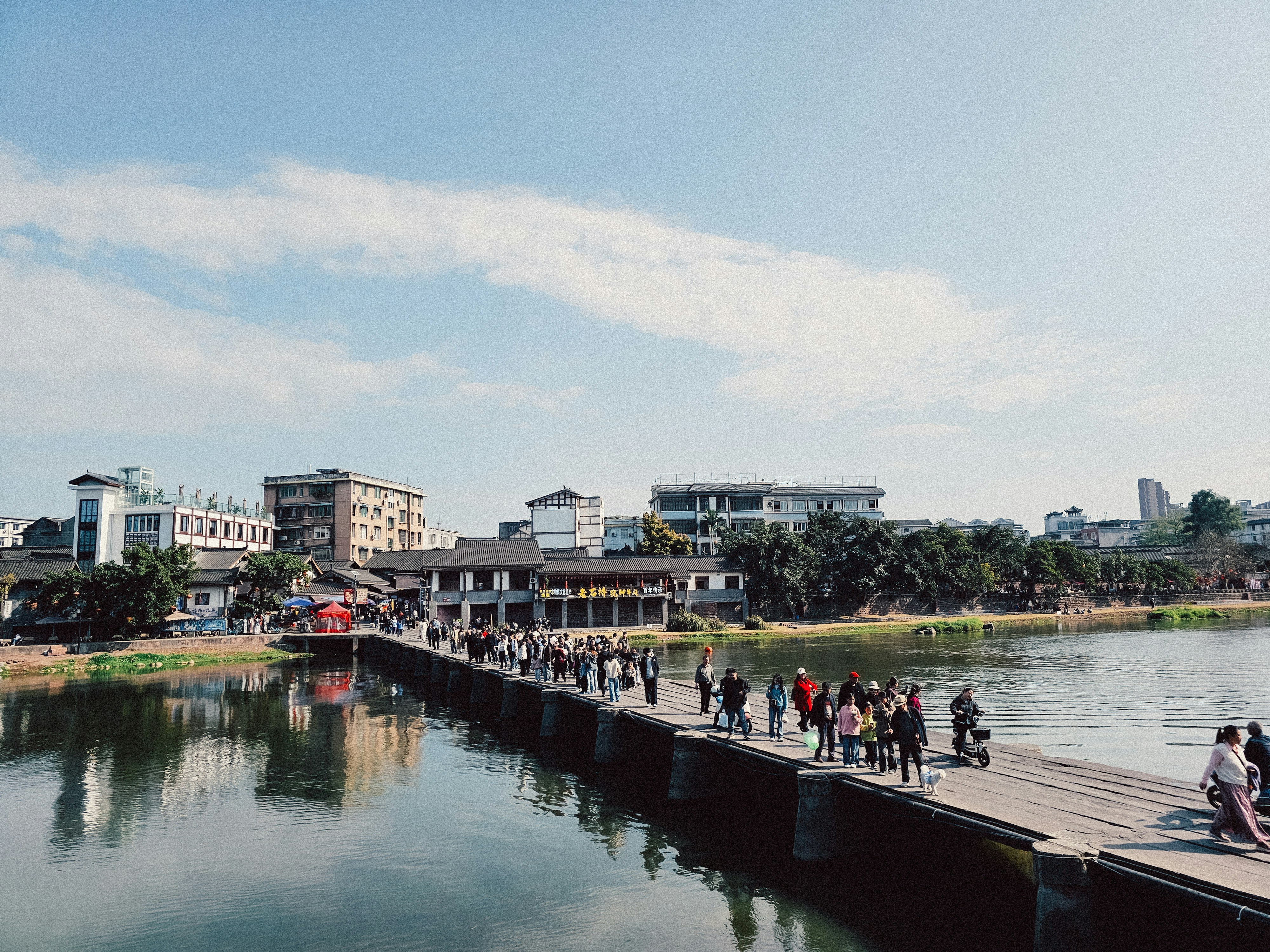 Bridge Walkers Across the River: A Quiet Day on the Waterfront Pier