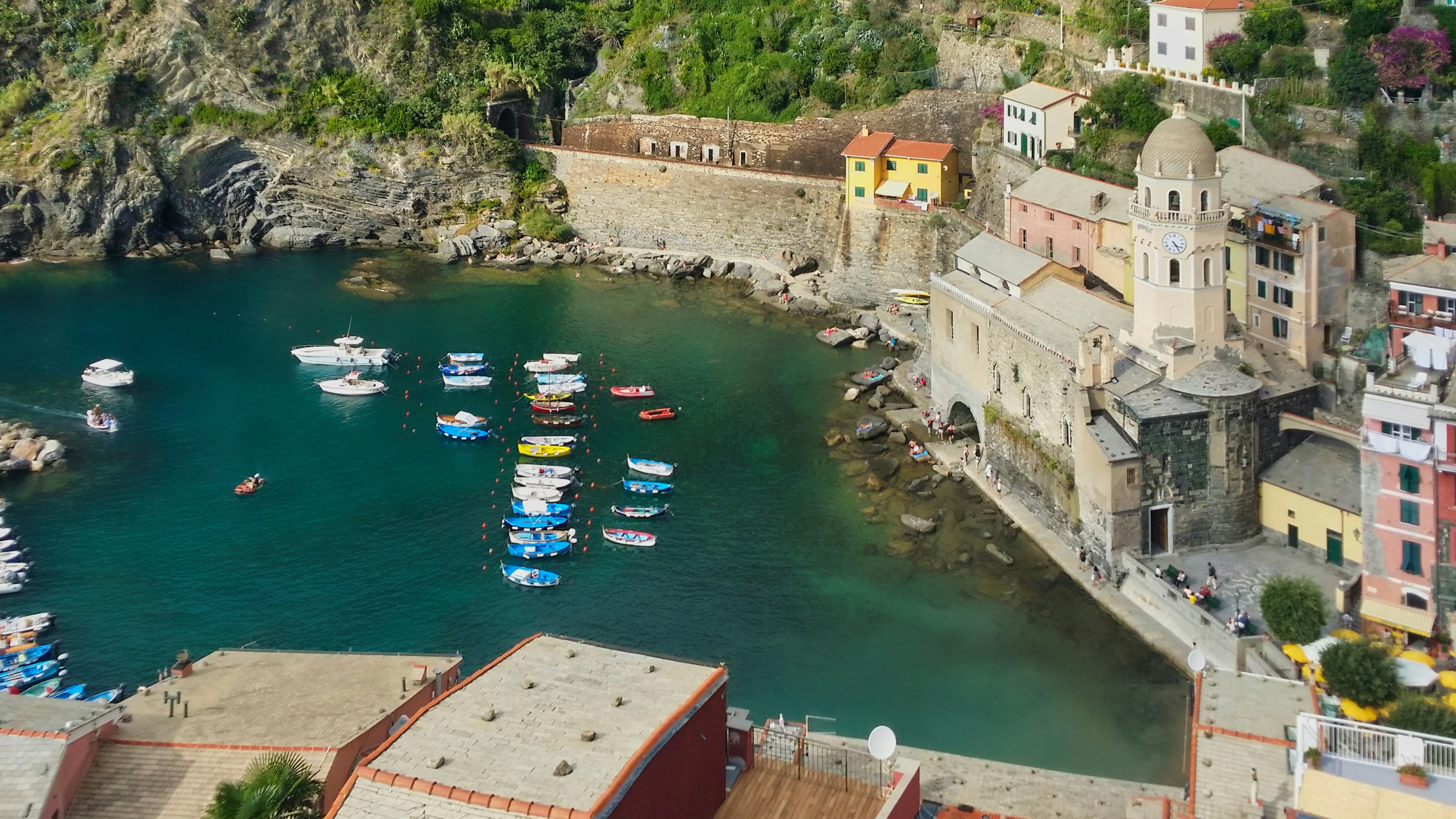 Colorful buildings line a harbor filled with boats.