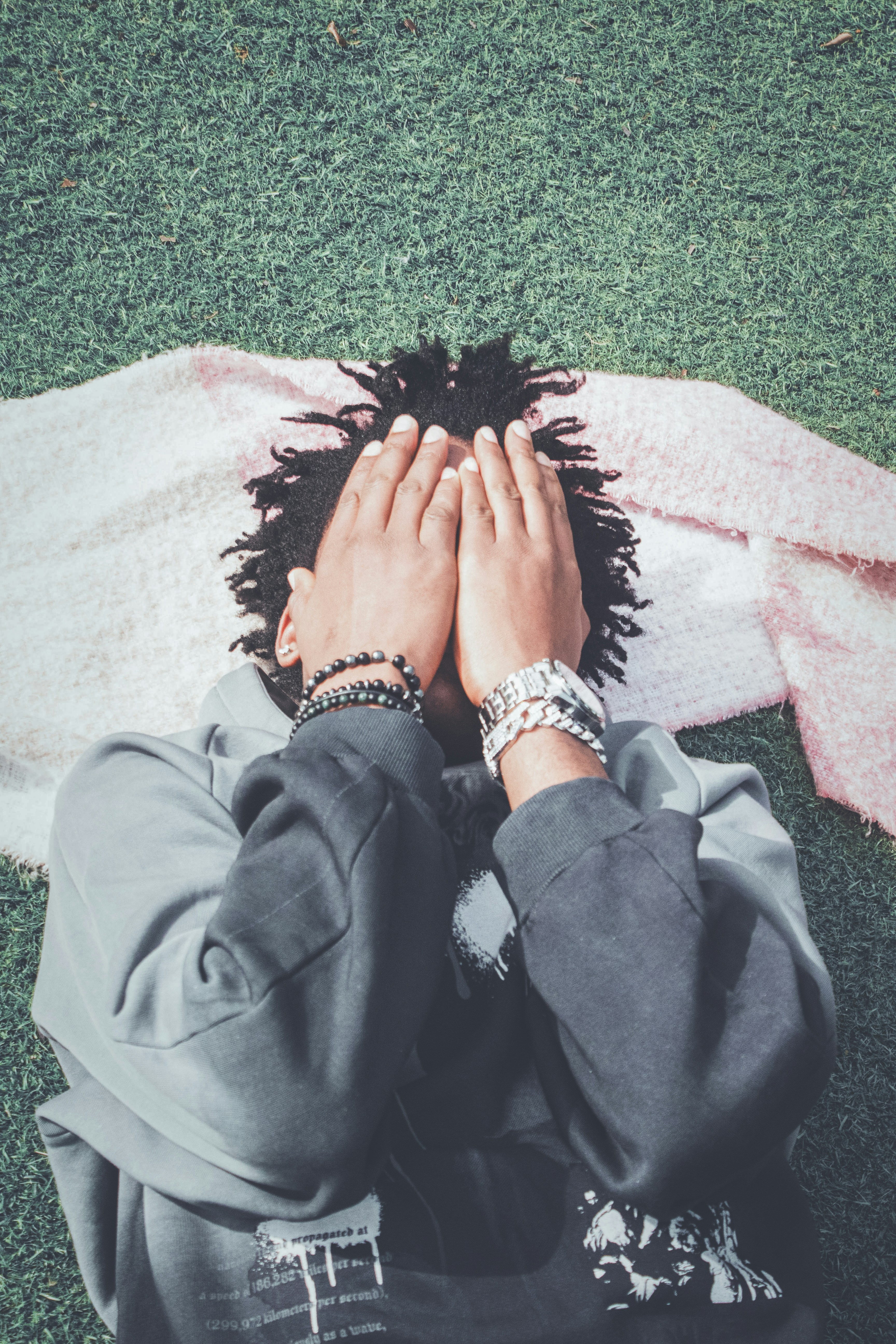 Hands Over Head: A Quiet Pause in the Grass