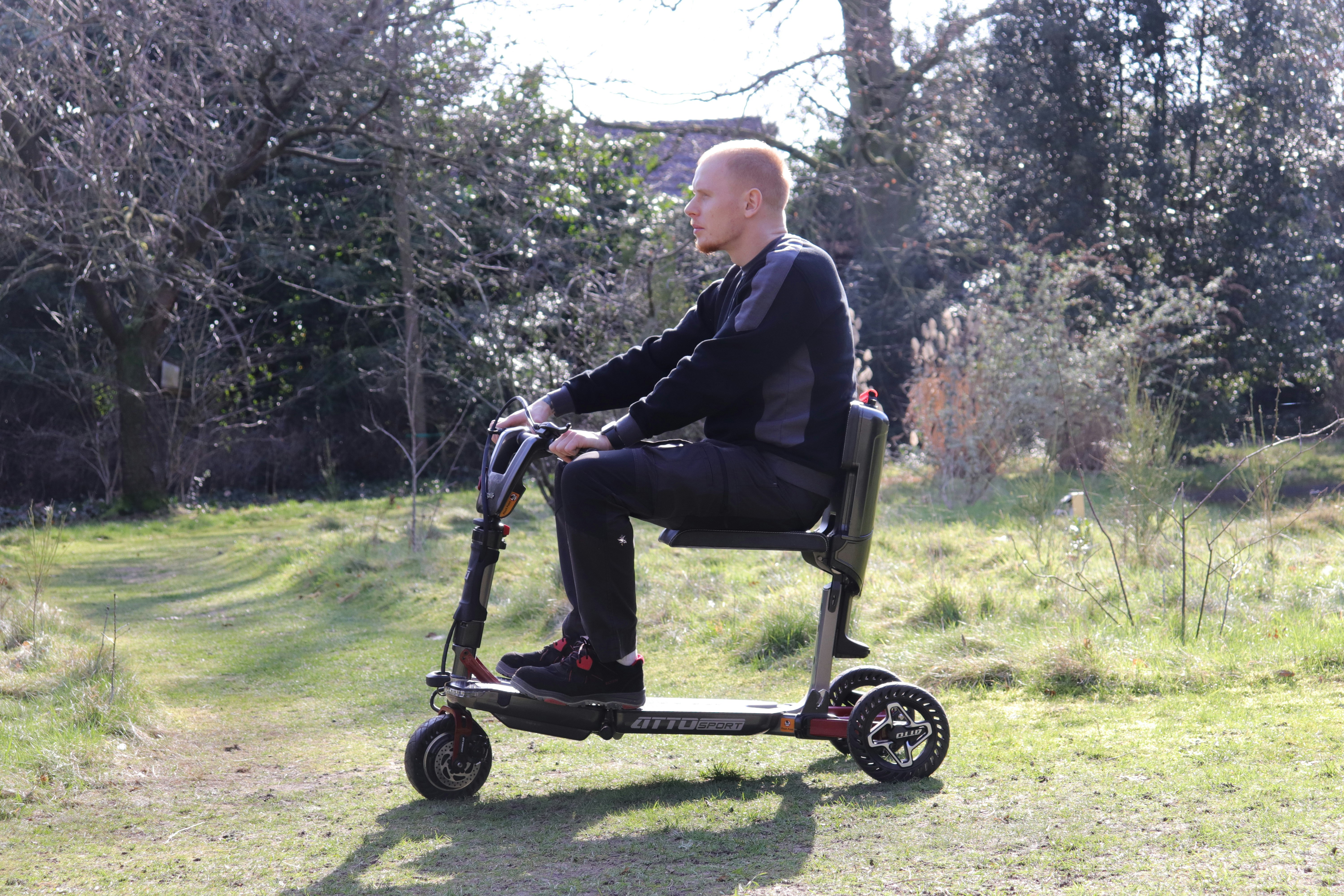 Rider in an Urban Meadow: A Quiet Ride on a Compact Electric Scooter