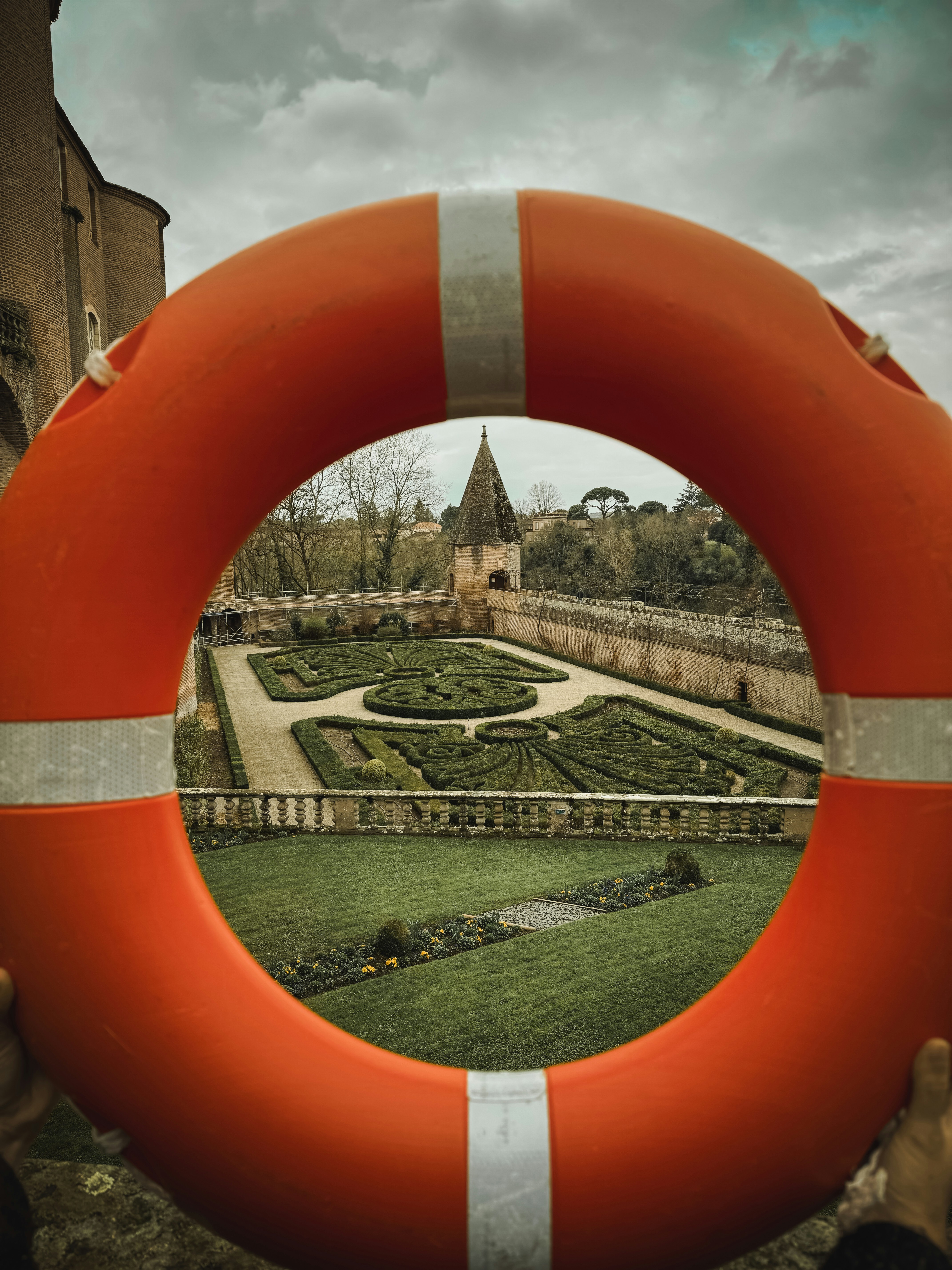 Circular Frame: A Lifebuoy Framing a Formal Garden Arch