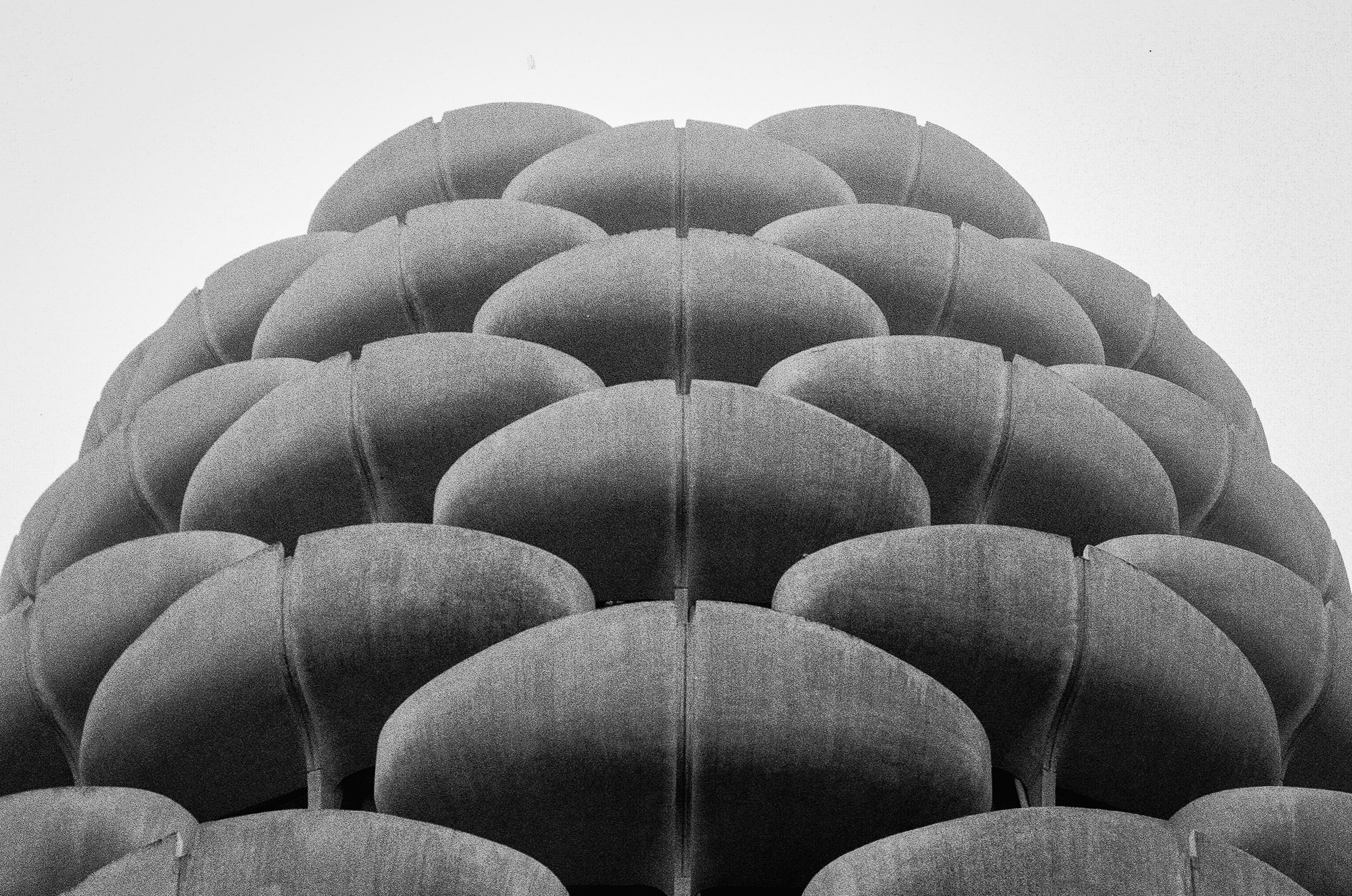 Black and white close-up of the iconic “Choux de Créteil” residential towers near Paris. The curved concrete balconies create a repeating sculptural pattern typical of 1970s French brutalist architecture. Shot on 35mm film with a Nikon F3 HP using Kentmere 400 black and white film.