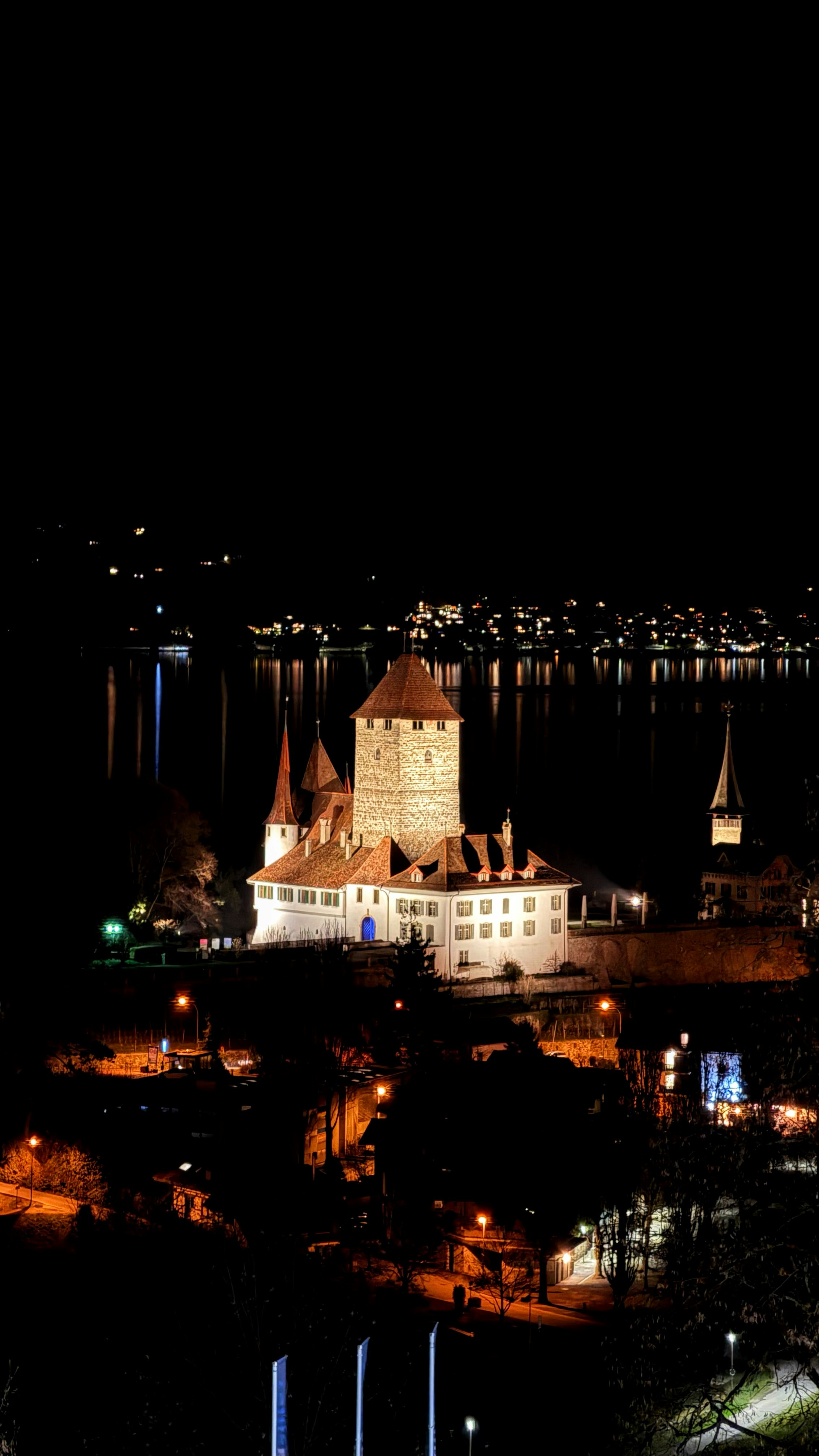 Castle by the Lake: Nighttime Silhouette of Kapellbrücke-like Turreted Abbey