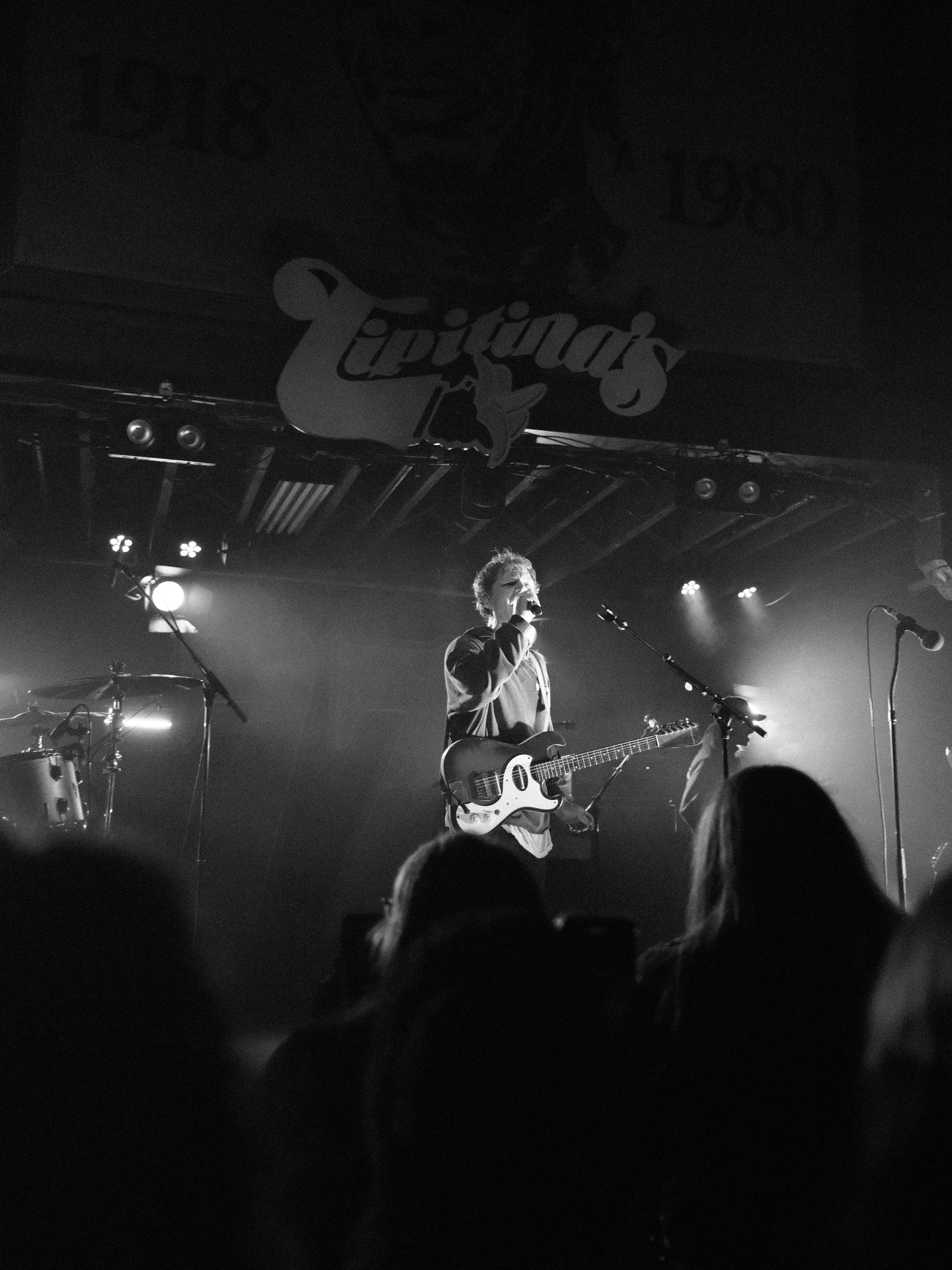 Midnight Echoes: A Guitarist Surrounded by Shadow and Light