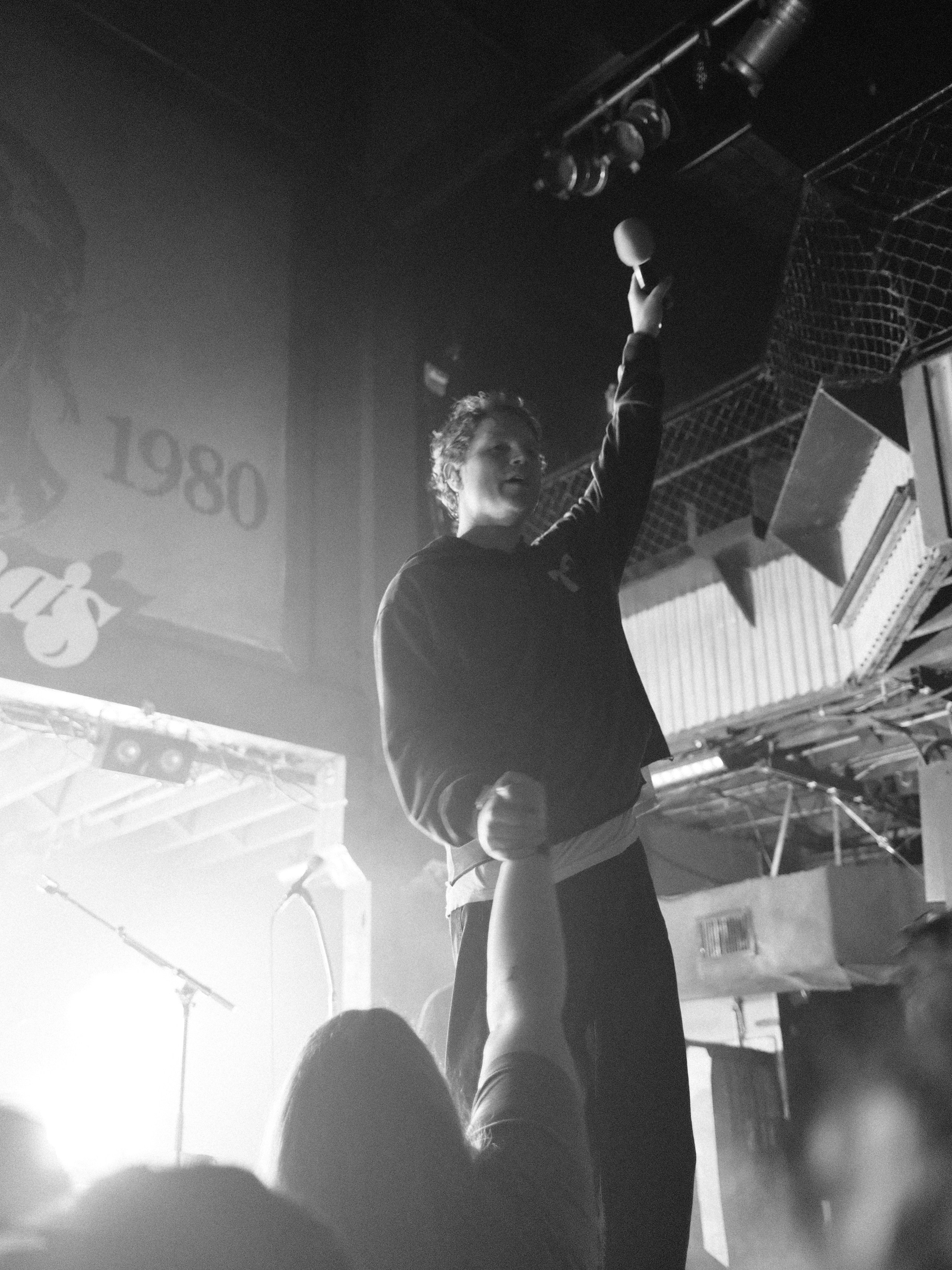 Holding Up the Moment: A Live Vocalist Reaches to the Crowd