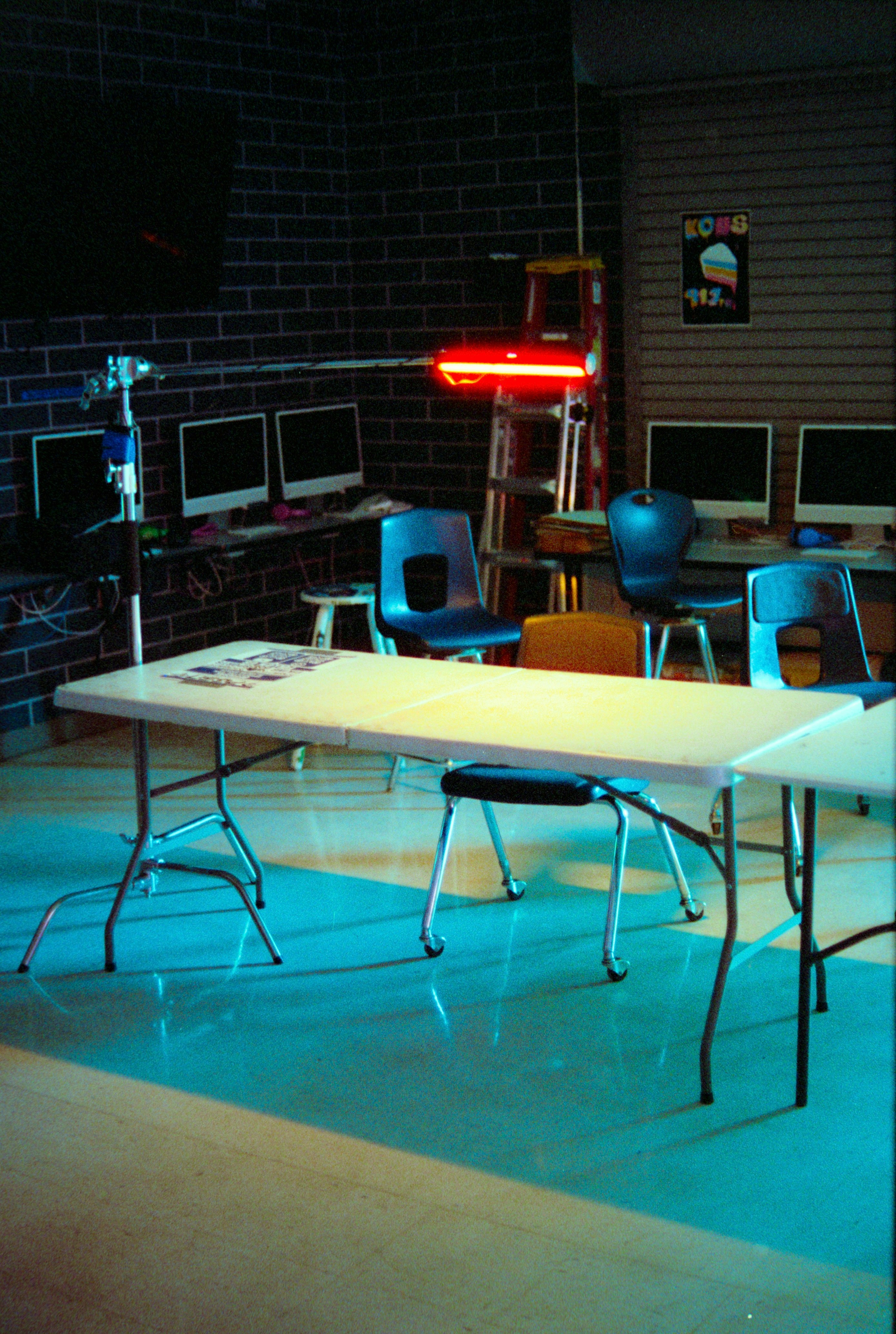 Dim Classroom After Hours: Neon Blue Light over an Empty Lab