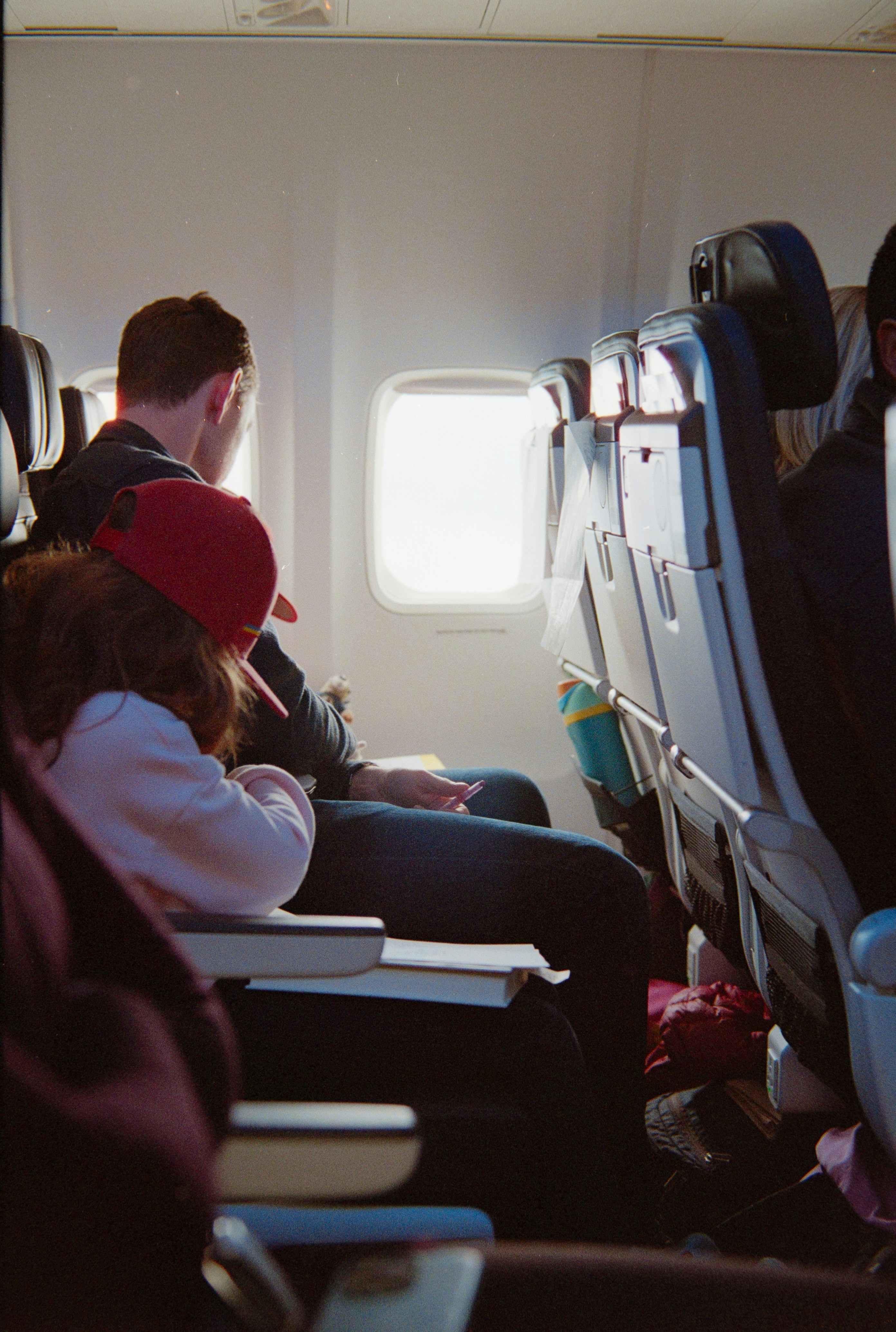 Window Light and Quiet Moment in an Aisle of Flight