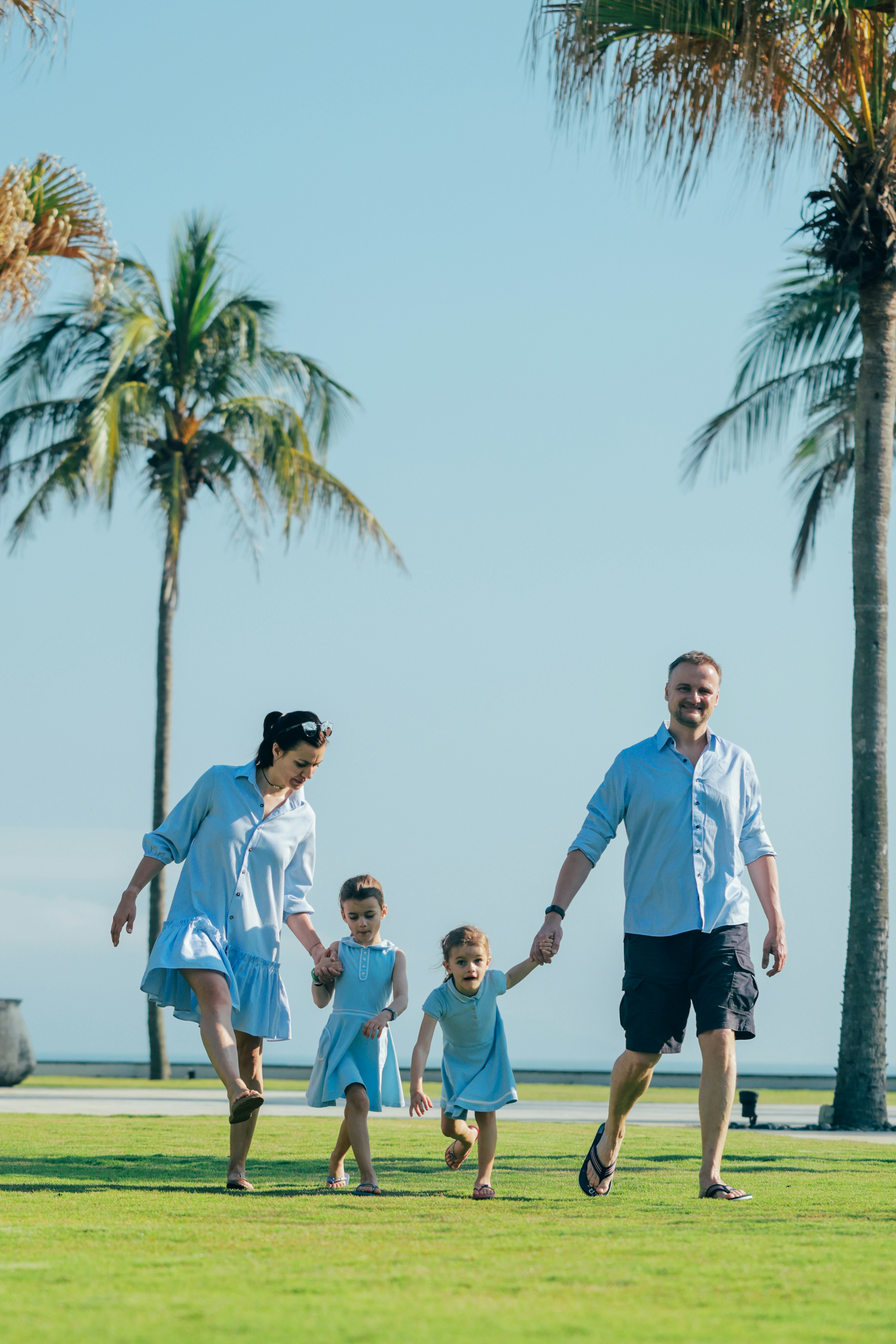 Family Stroll Under Palm Trees: A Sunny Beachside Moment