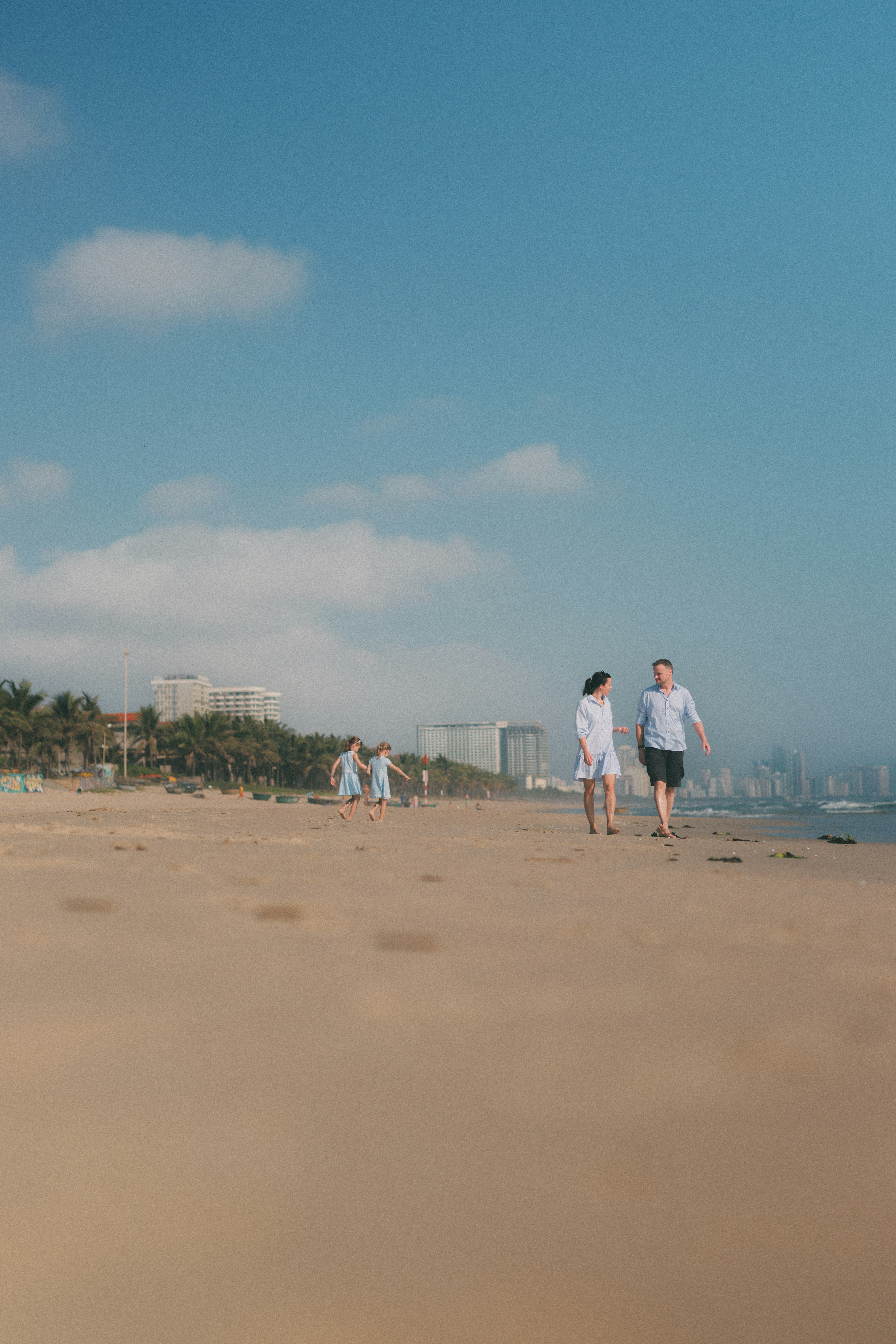Coastal stroll: a sunlit beachfront family moment