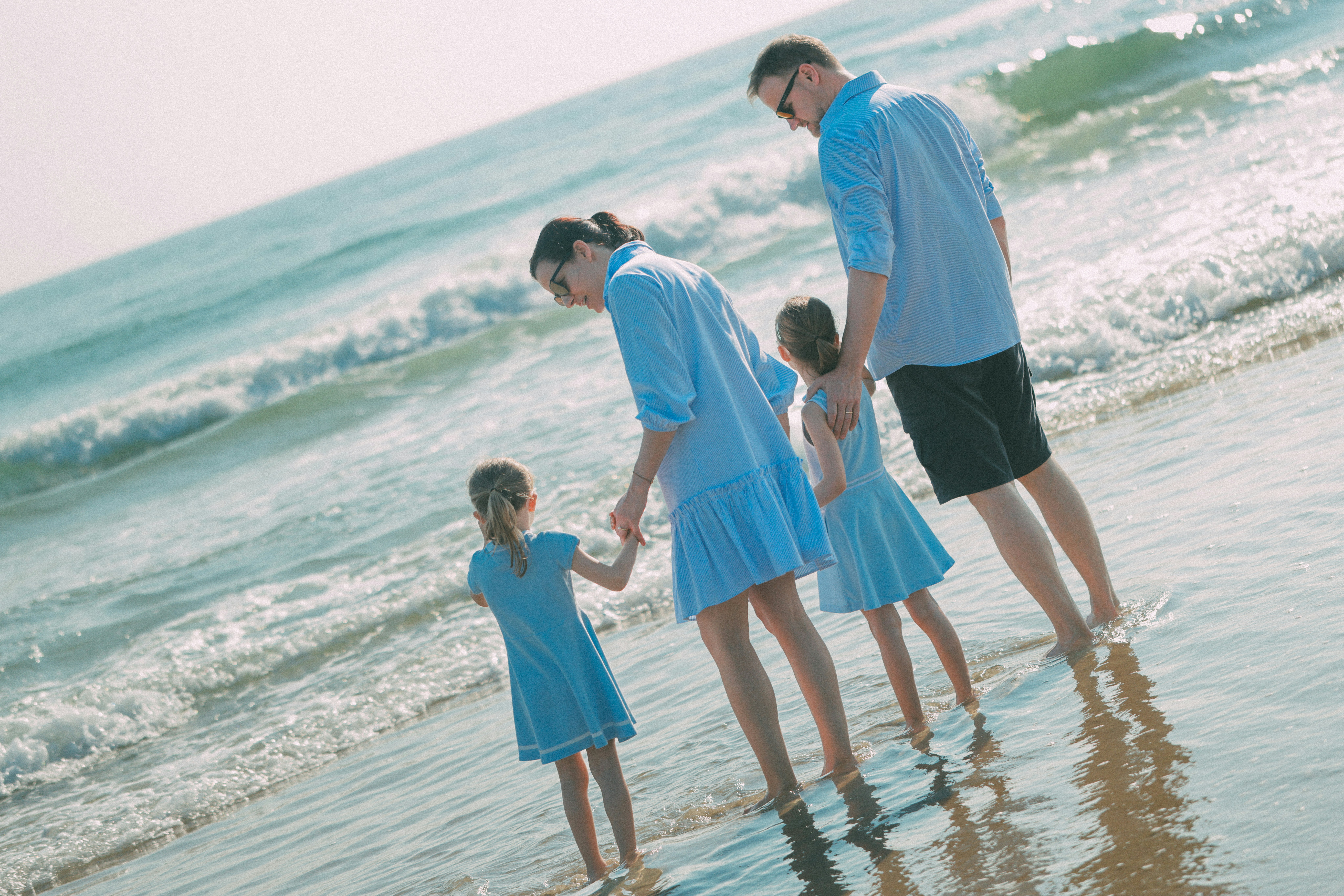 Blue Family on the Shore: Gentle Walk by the Sea