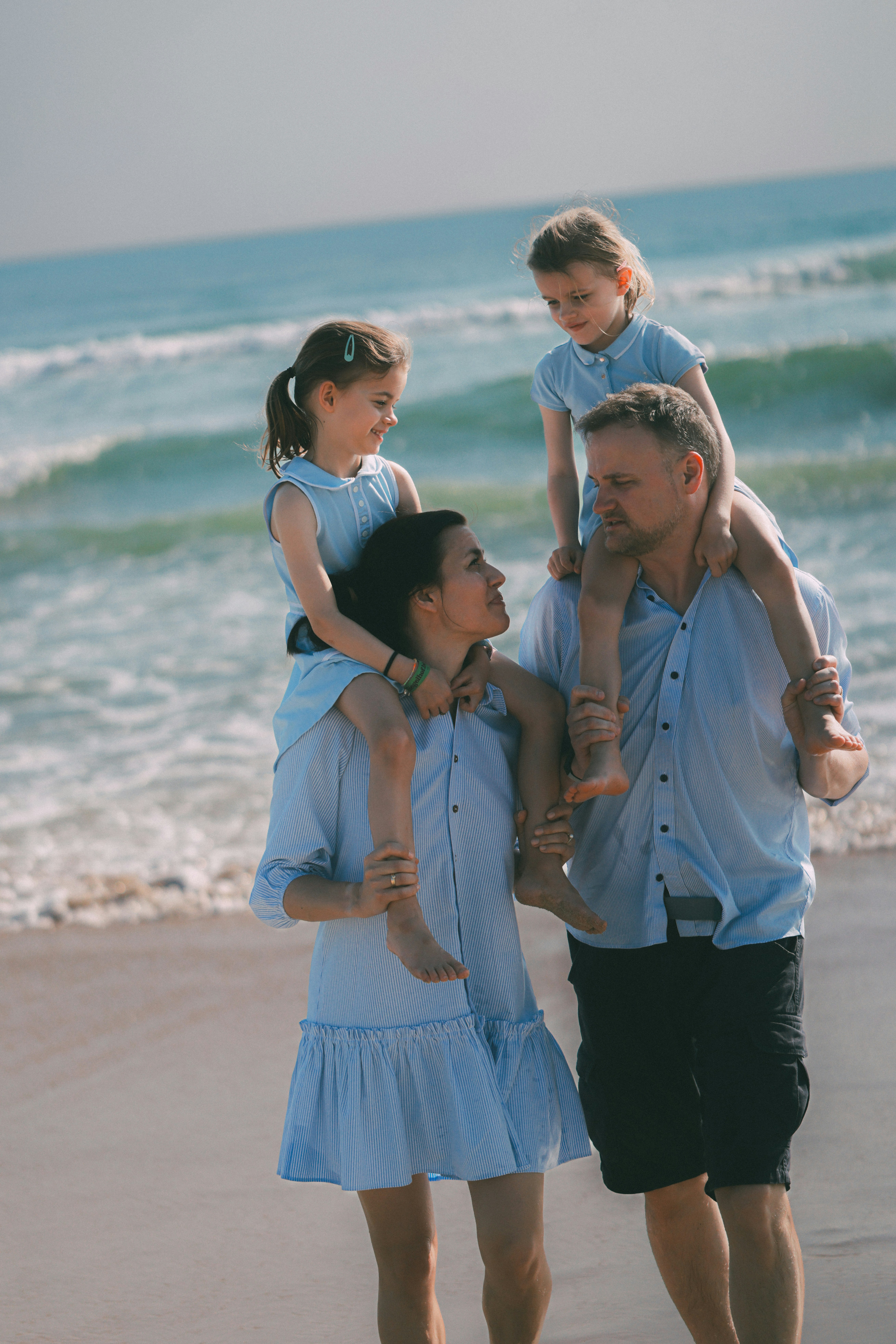 Sunlit Seashells & Smiles: A Family Moment on the Shore