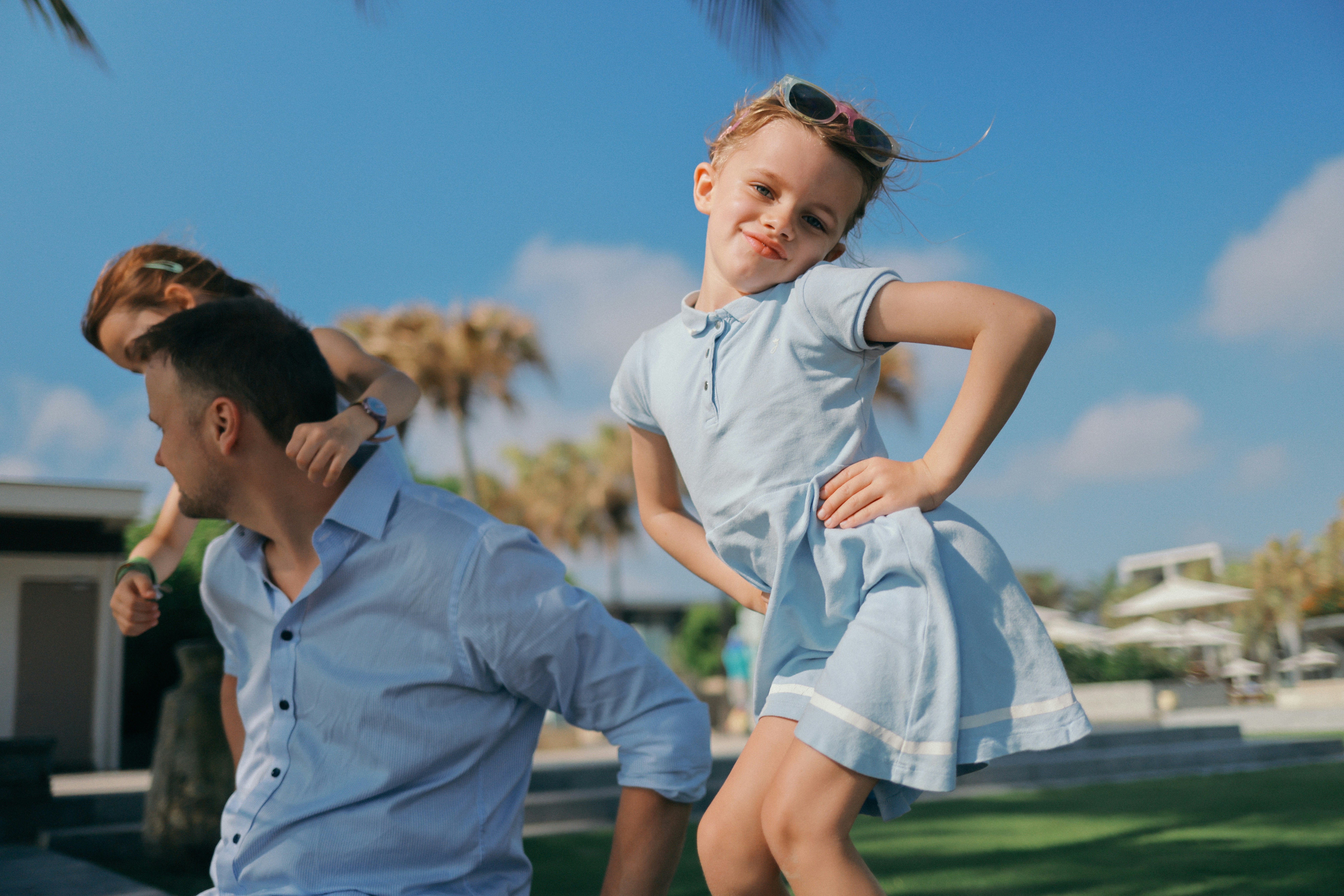 A young girl poses with her family outdoors