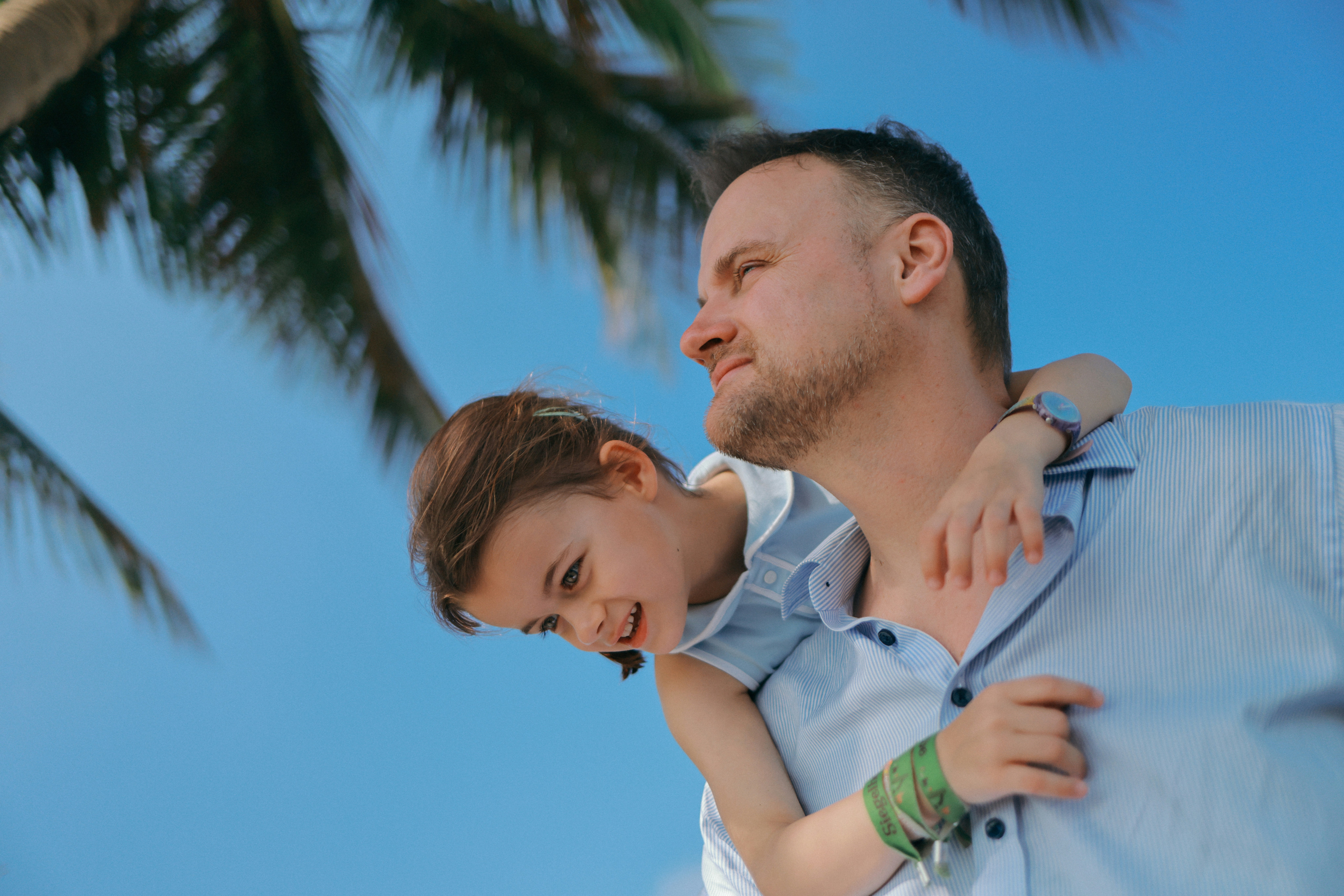 Carried by Trust: Father and Daughter Ride the Ocean Breeze
