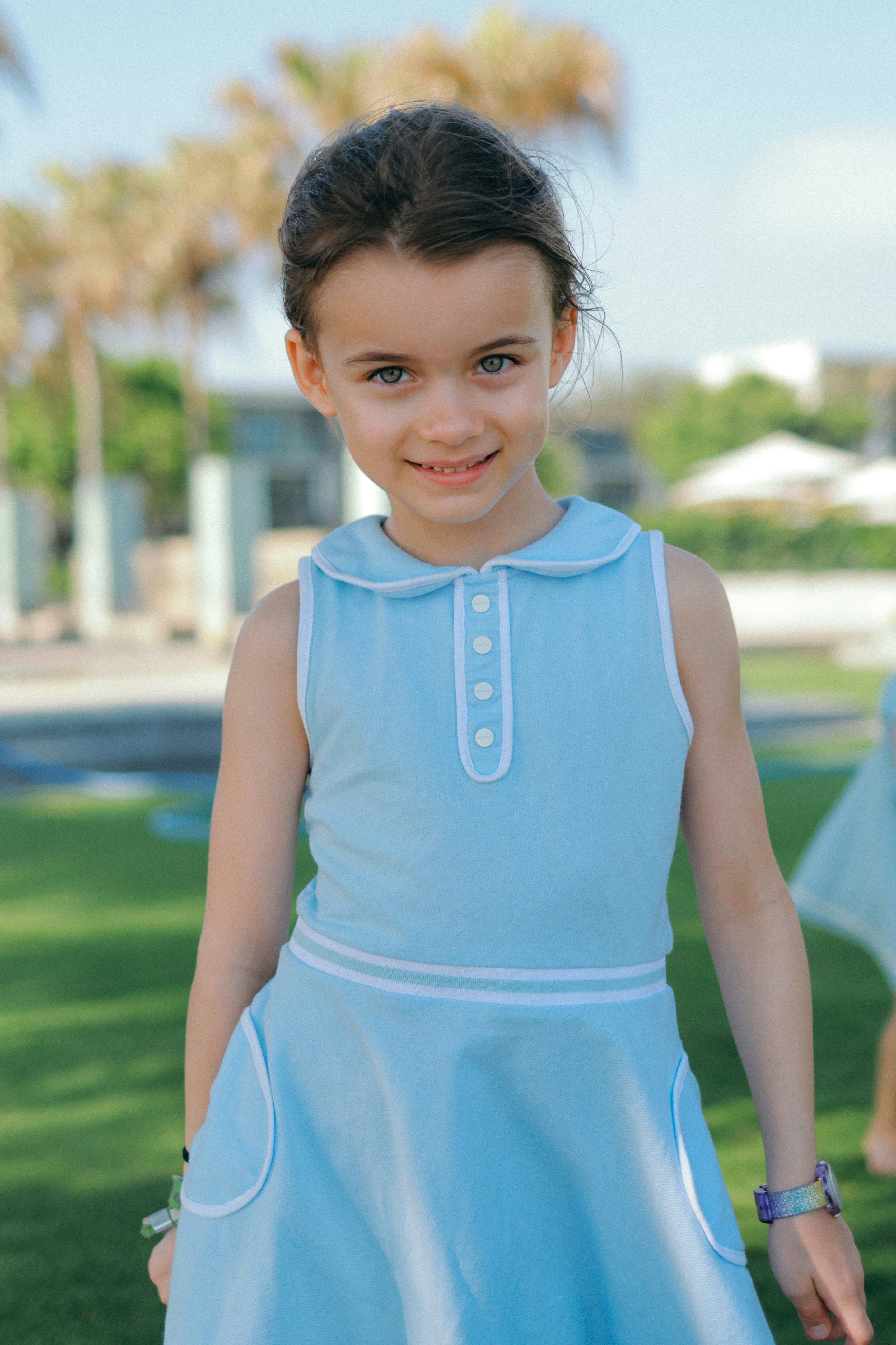 Blue-dressed girl at the sunny park
