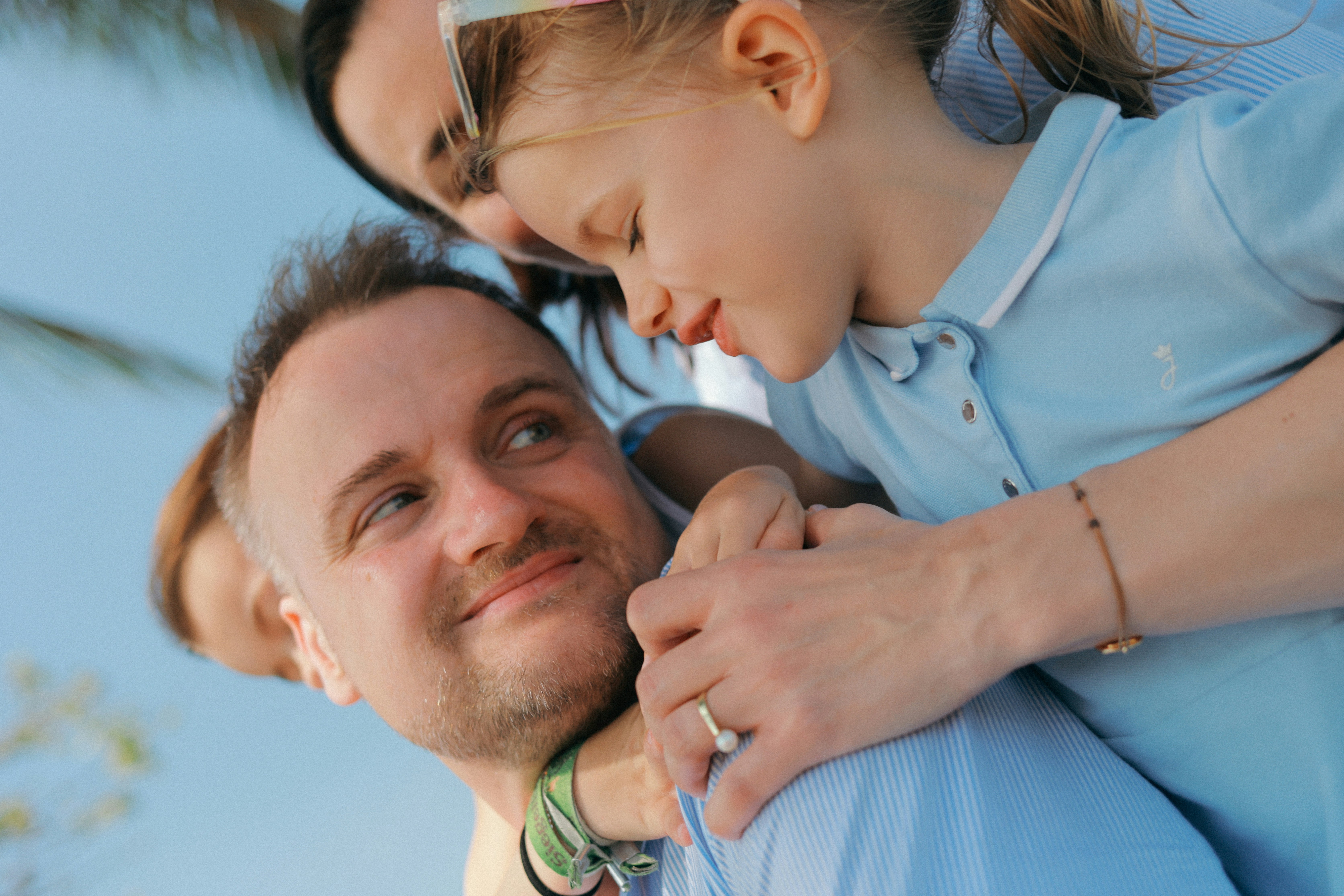 Shared Moment Under Blue Skies: Father and Daughter Embrace