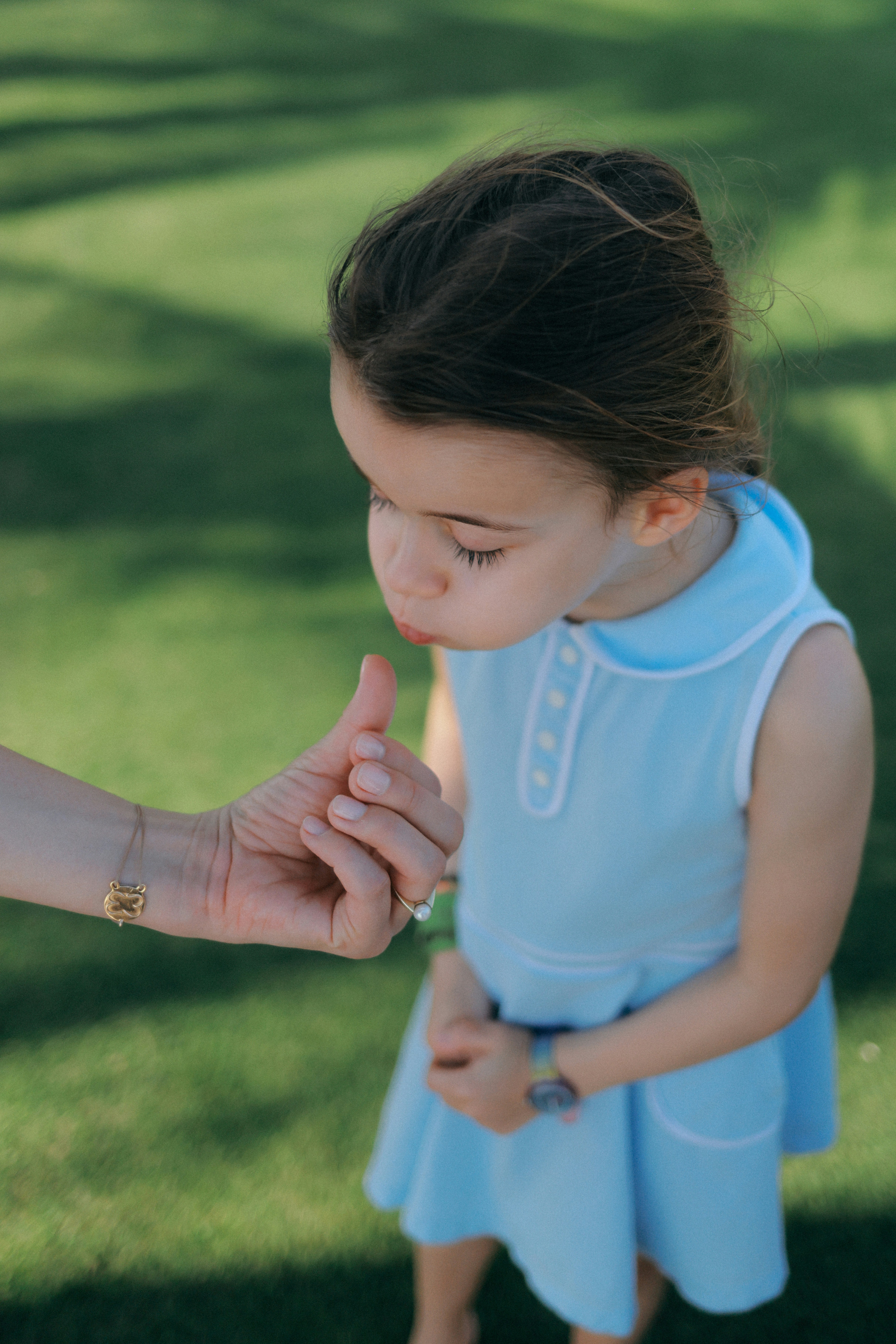 Tender Moment: A Tiny Hand Guided by a Loving Touch
