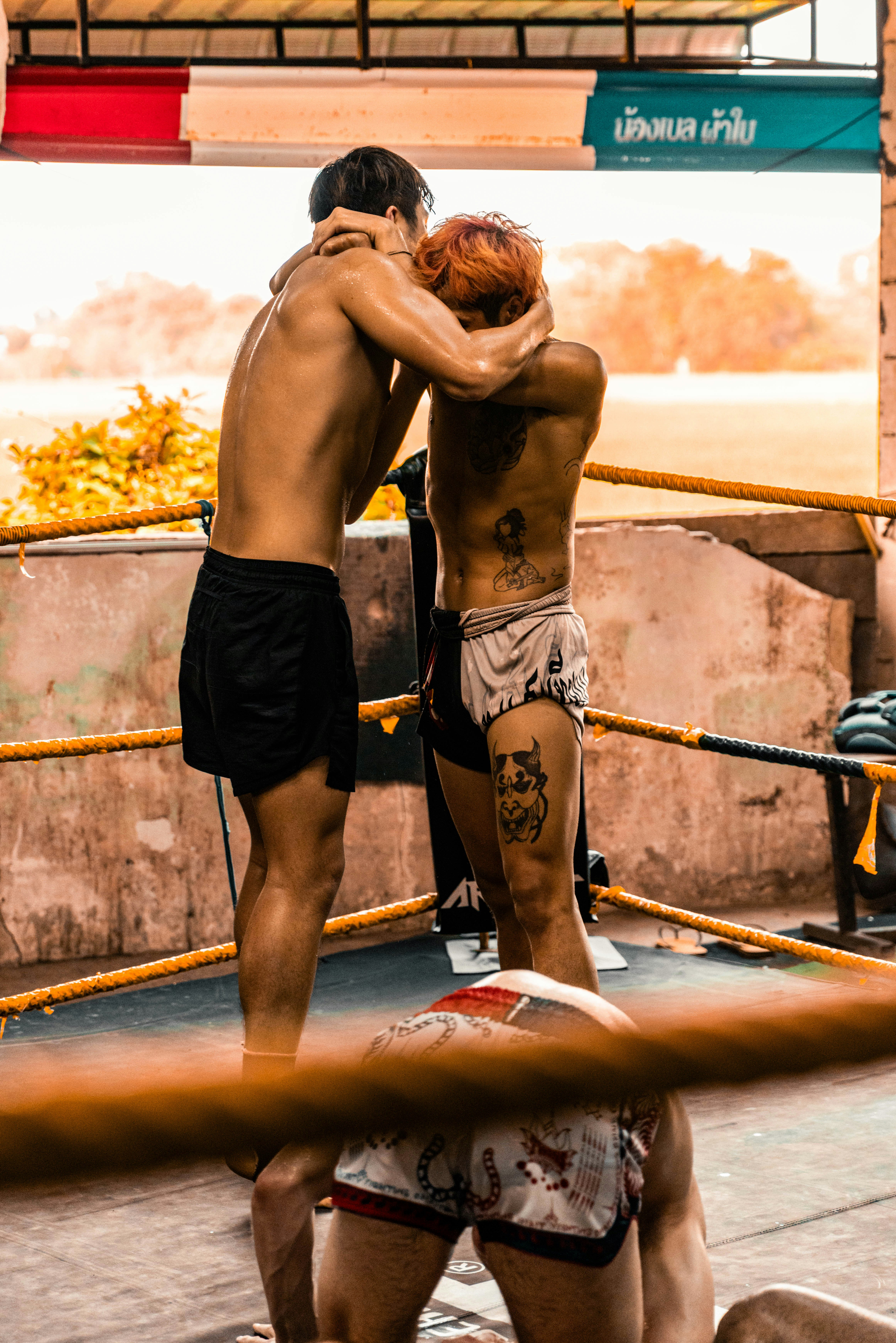 Ringside Embrace: Two Fighters Consoling Each Other After a Round