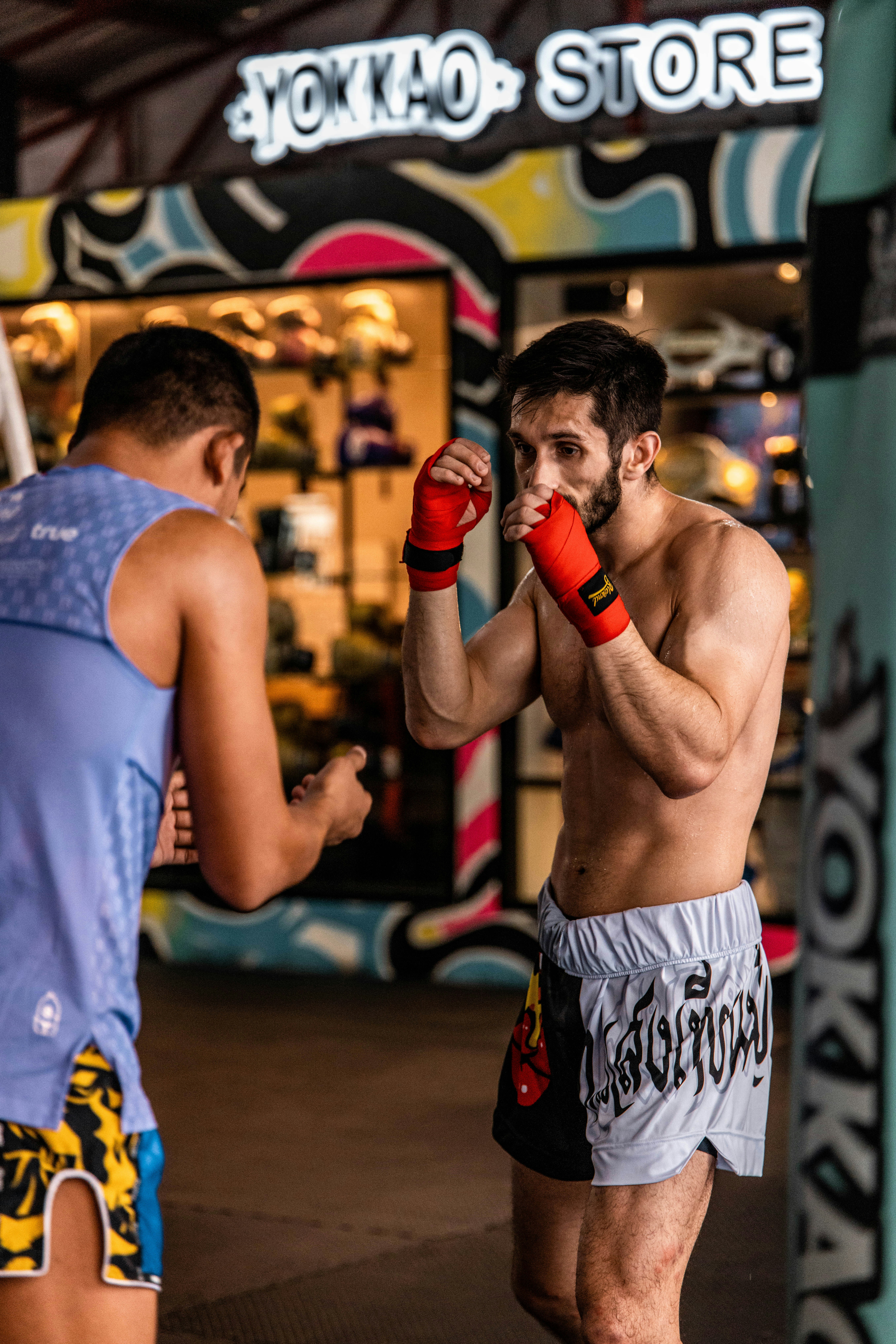 Gloves Up: A Scrappy Training Moment in a Colorful Gym