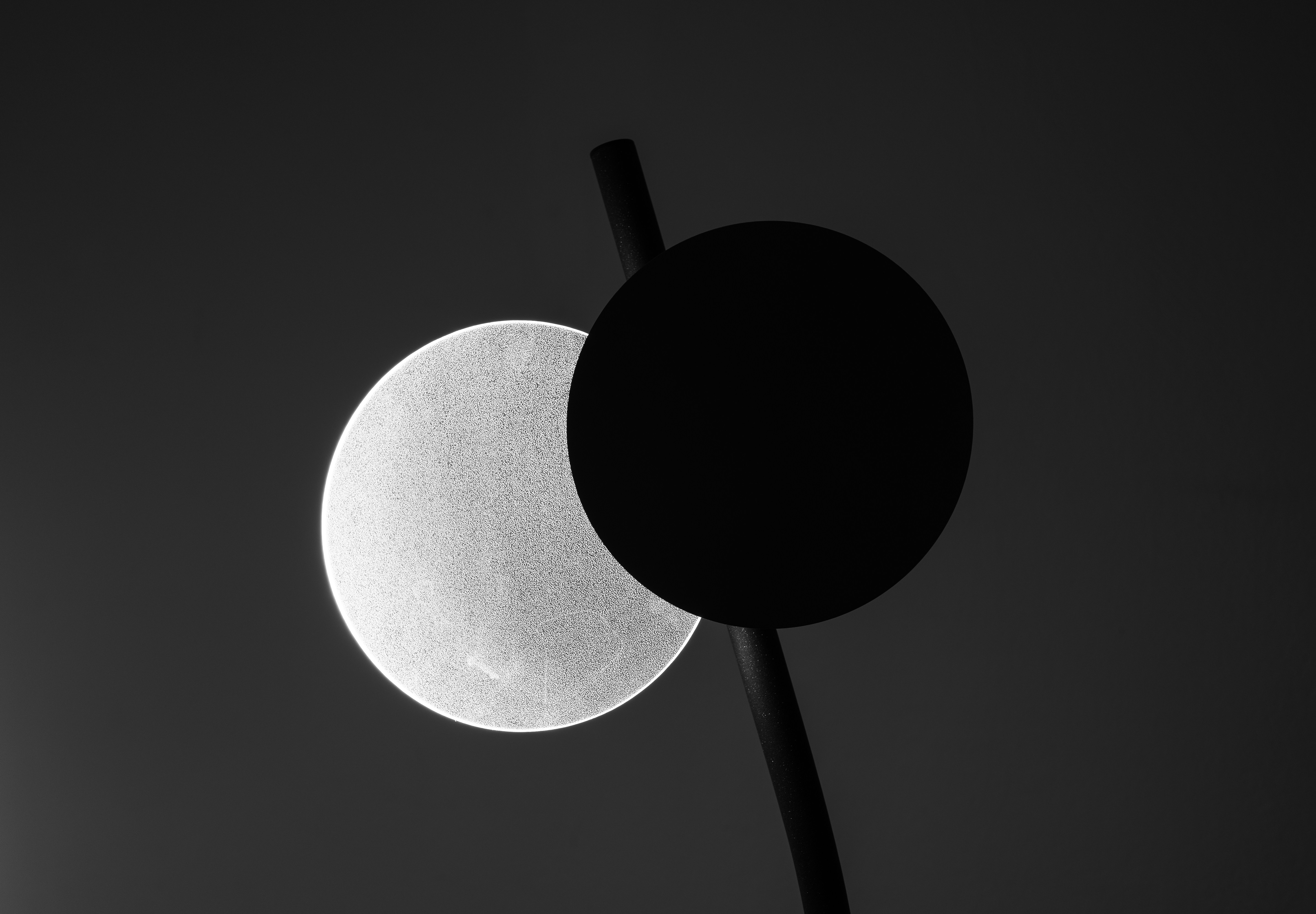 Moonlit Ring duet: a dark orb overlaps a pale crescent against a gradient sky
