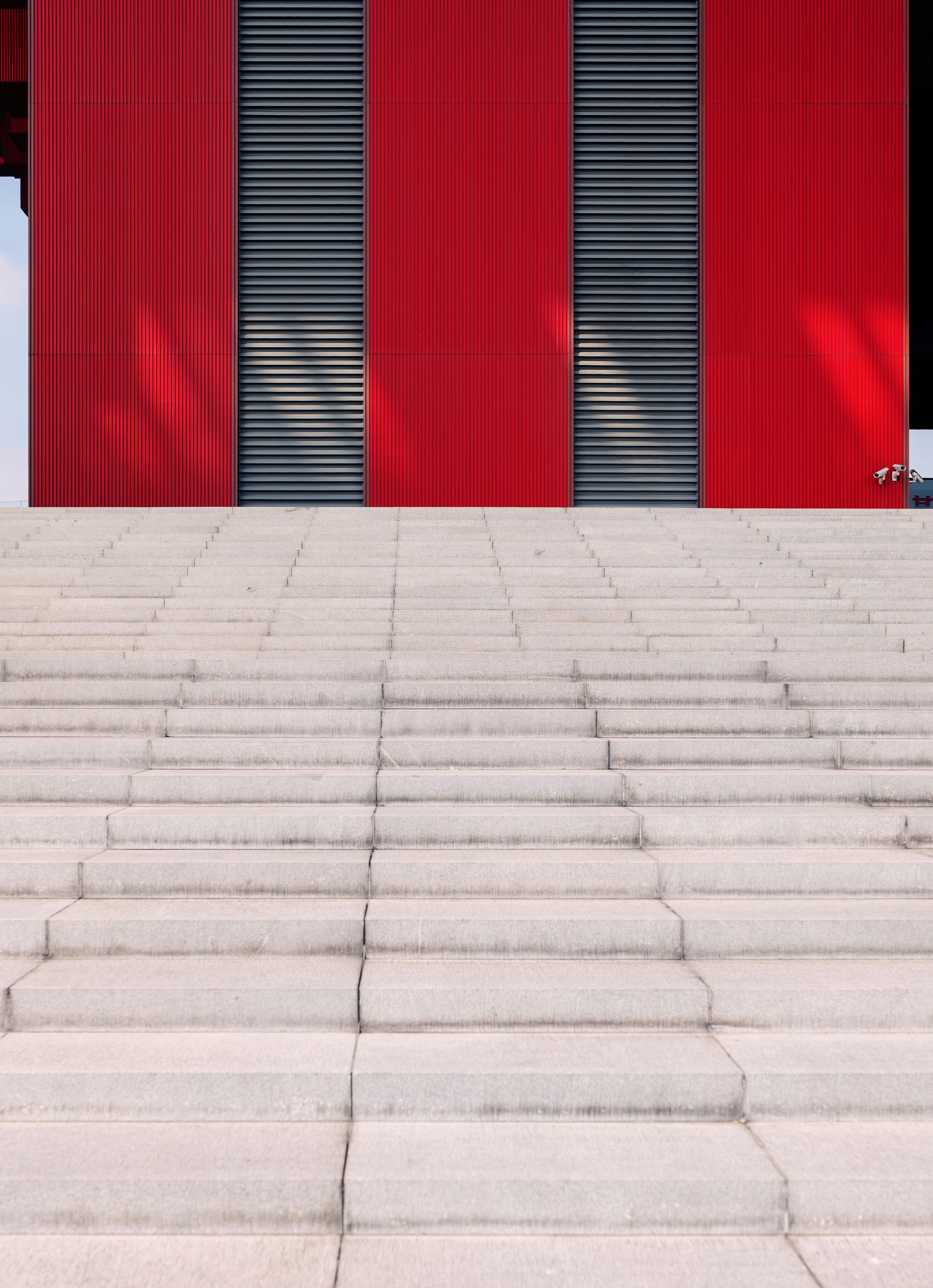 Red Facade and Streaked Shadows Over Wide Steps