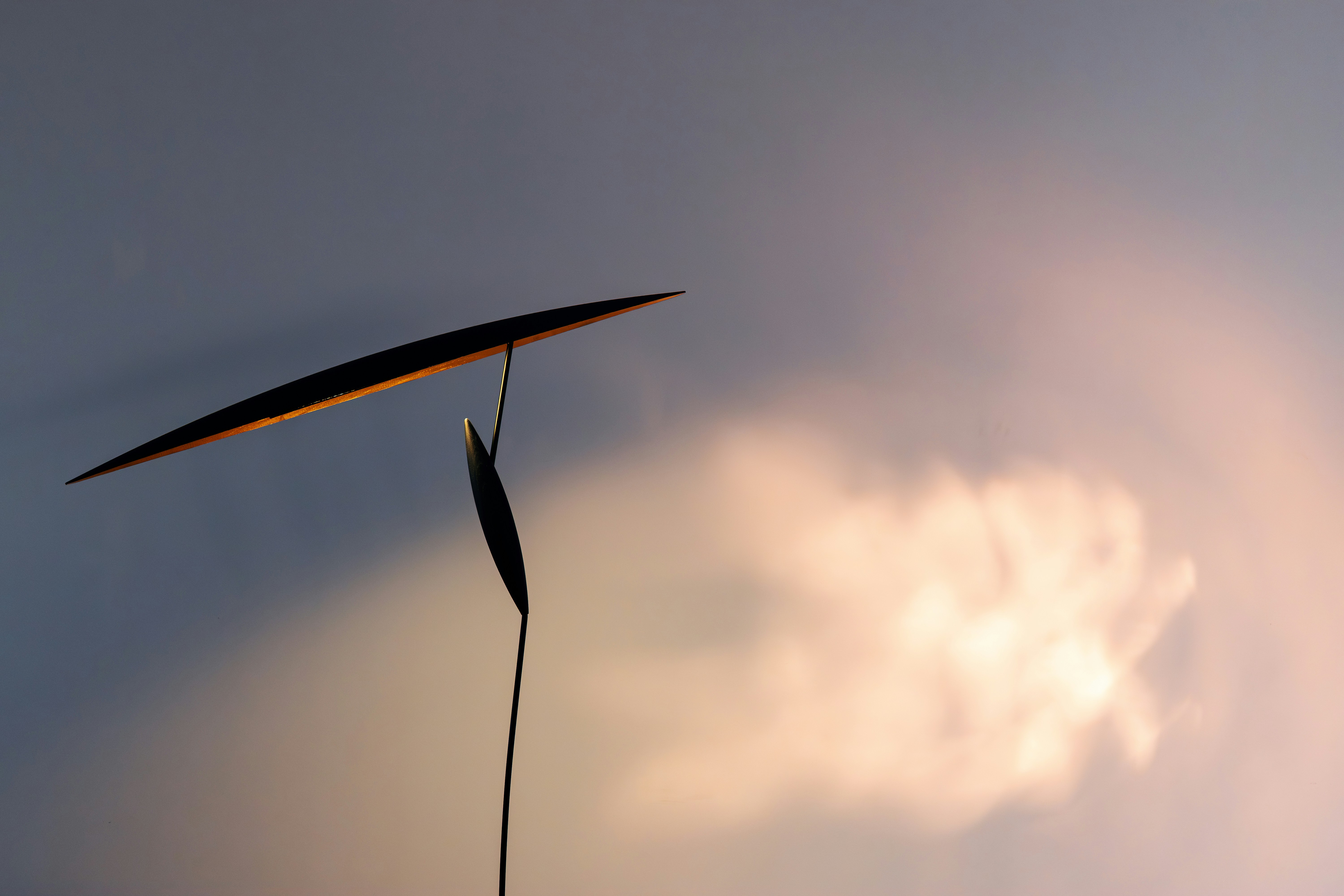 Minimal kite-like blade against a pastel sky at dusk