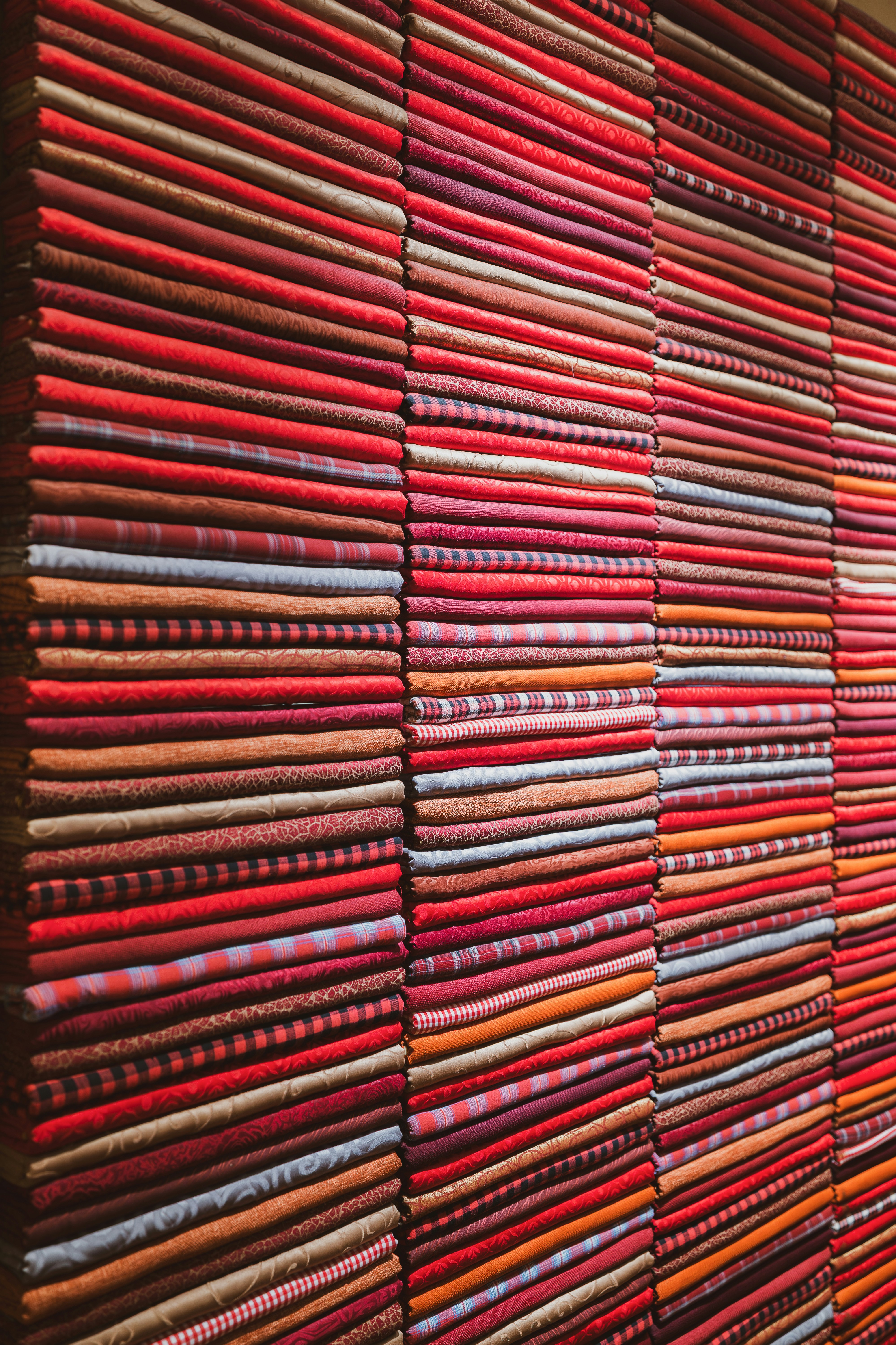 A Cascade of Colorful Fabrics: Tightly Stacked Hues in a Textile Wall