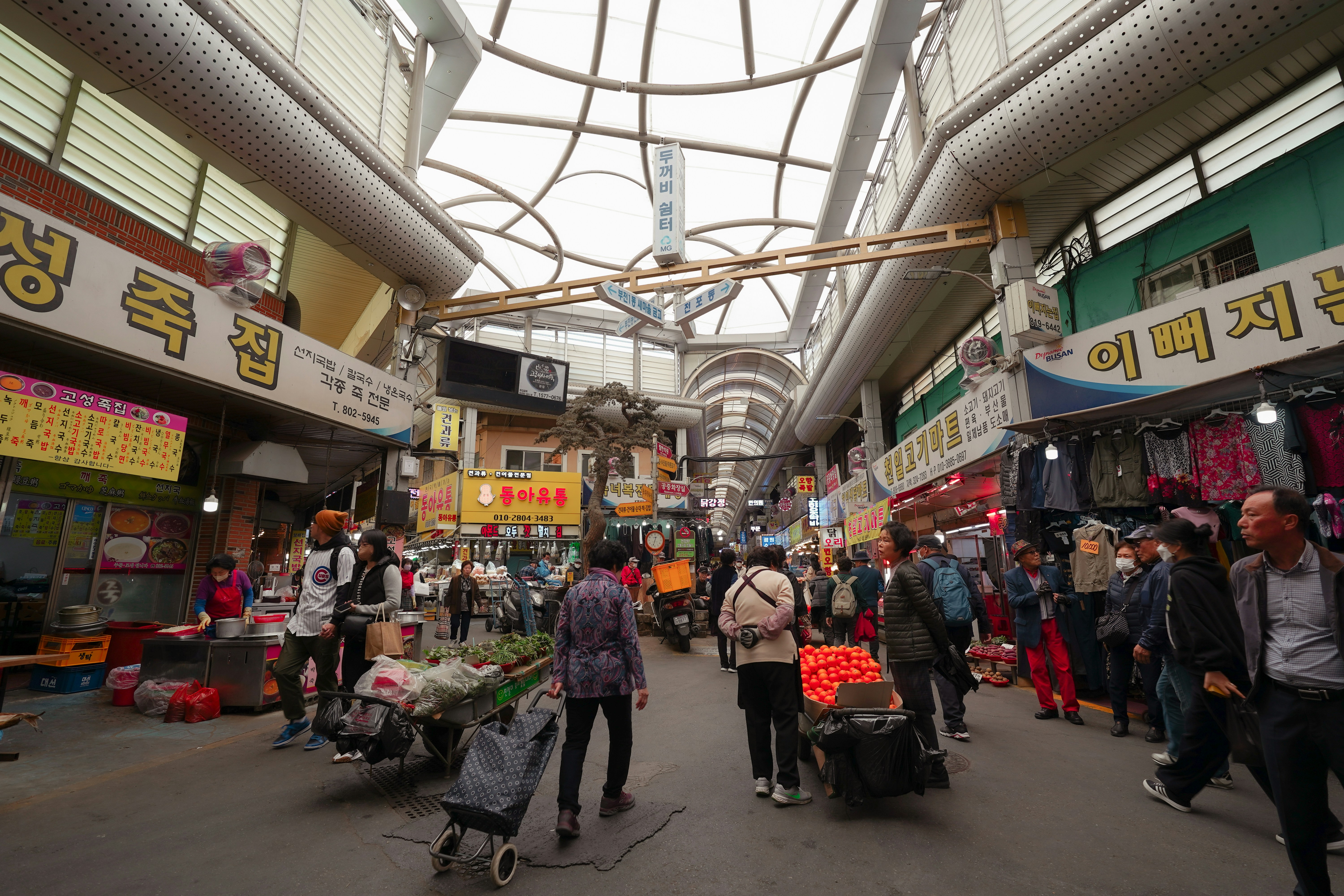 Urban Bazaar Corridor: People, Stalls, and Overhead Structures