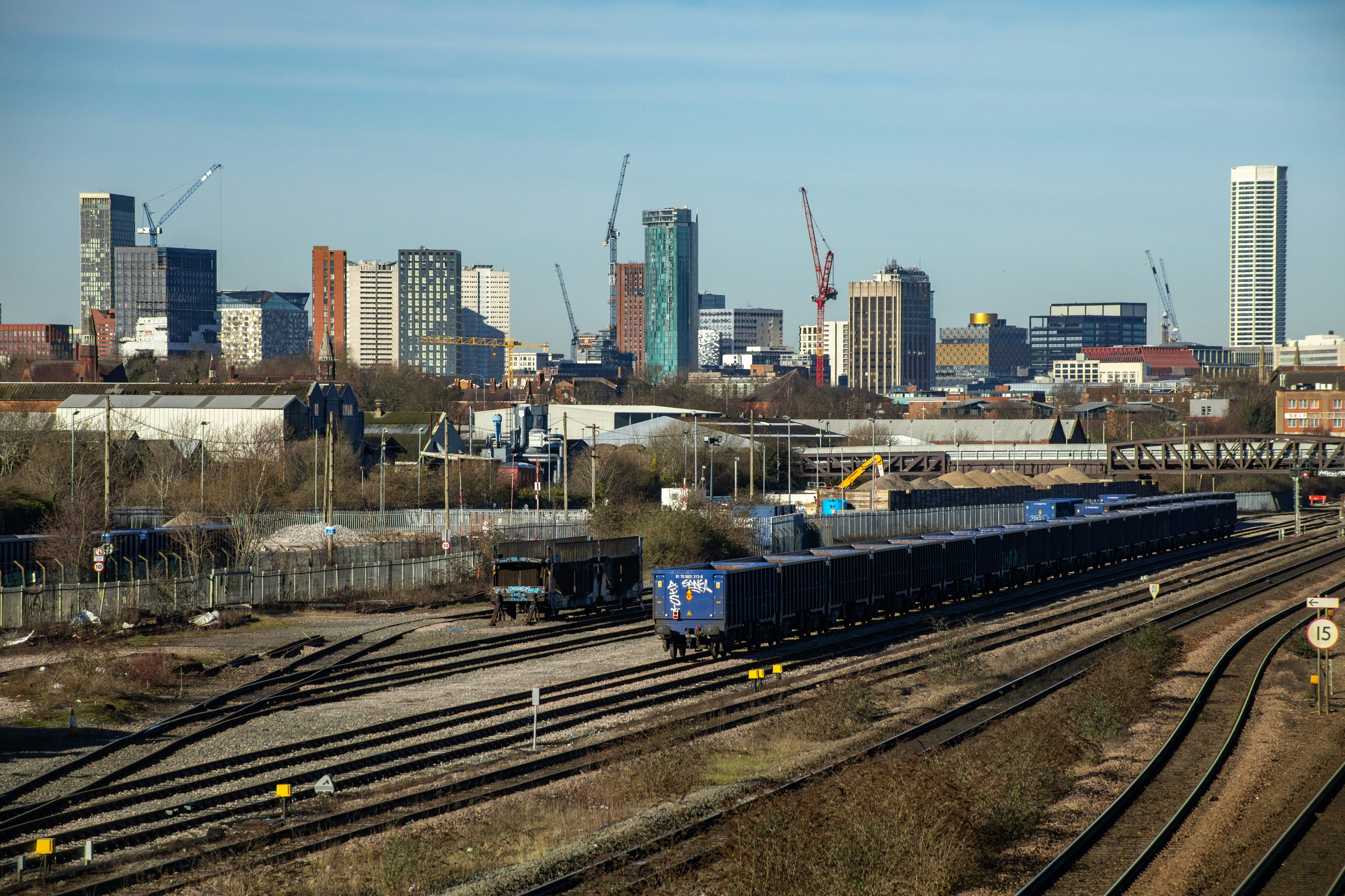 Urban Rails: Freight Lines Crossing a Modern City Horizon
