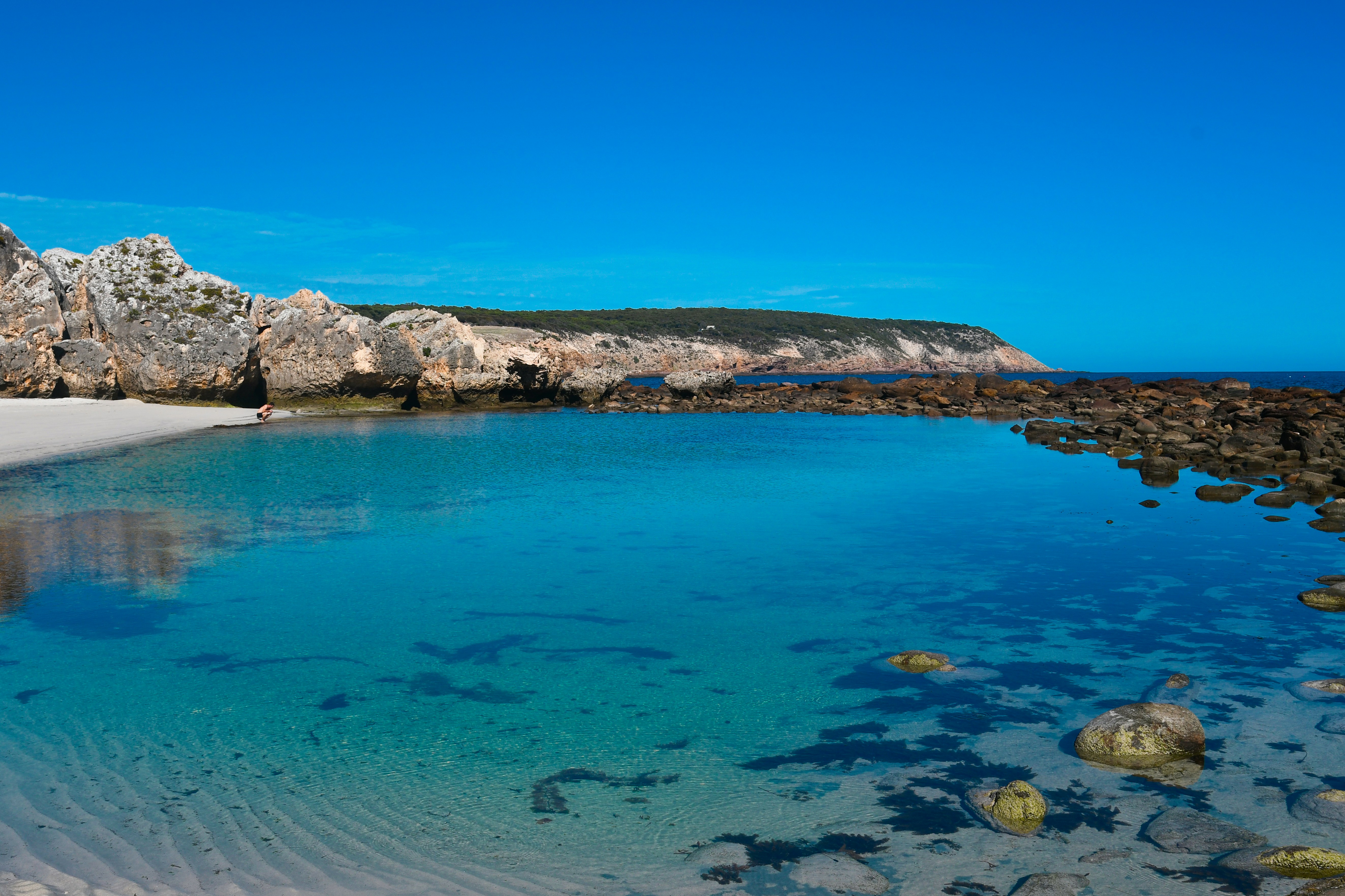Turquoise Cove: Calm Waters and Weathered Rocks