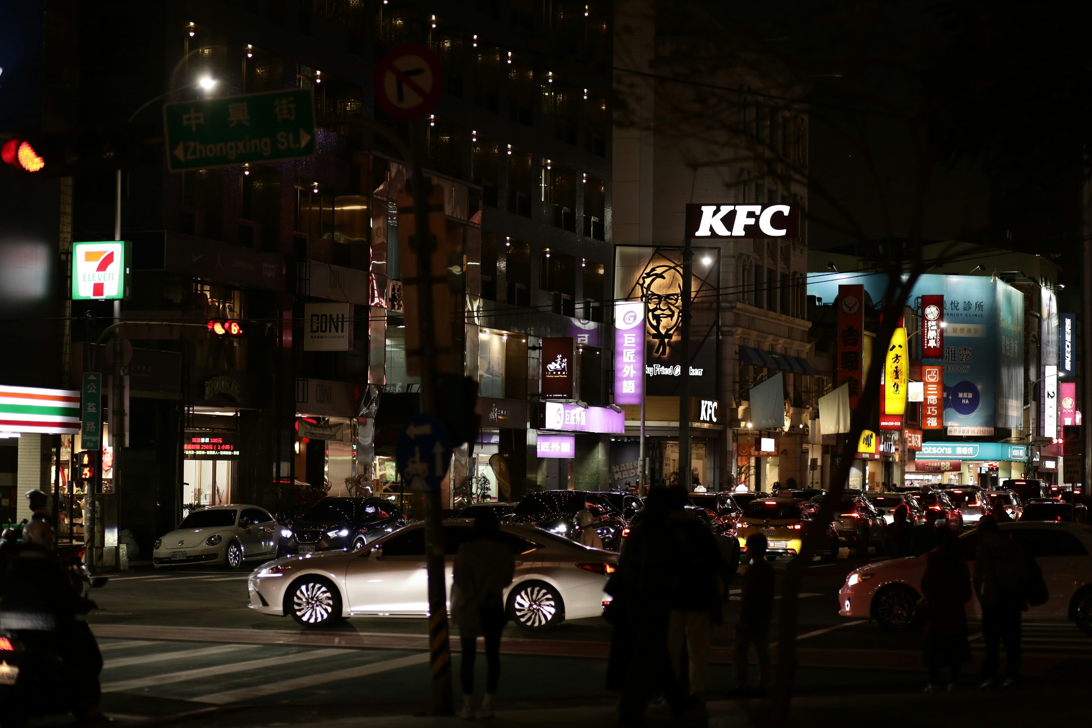 Neon Nights at a Bustling Crosswalk