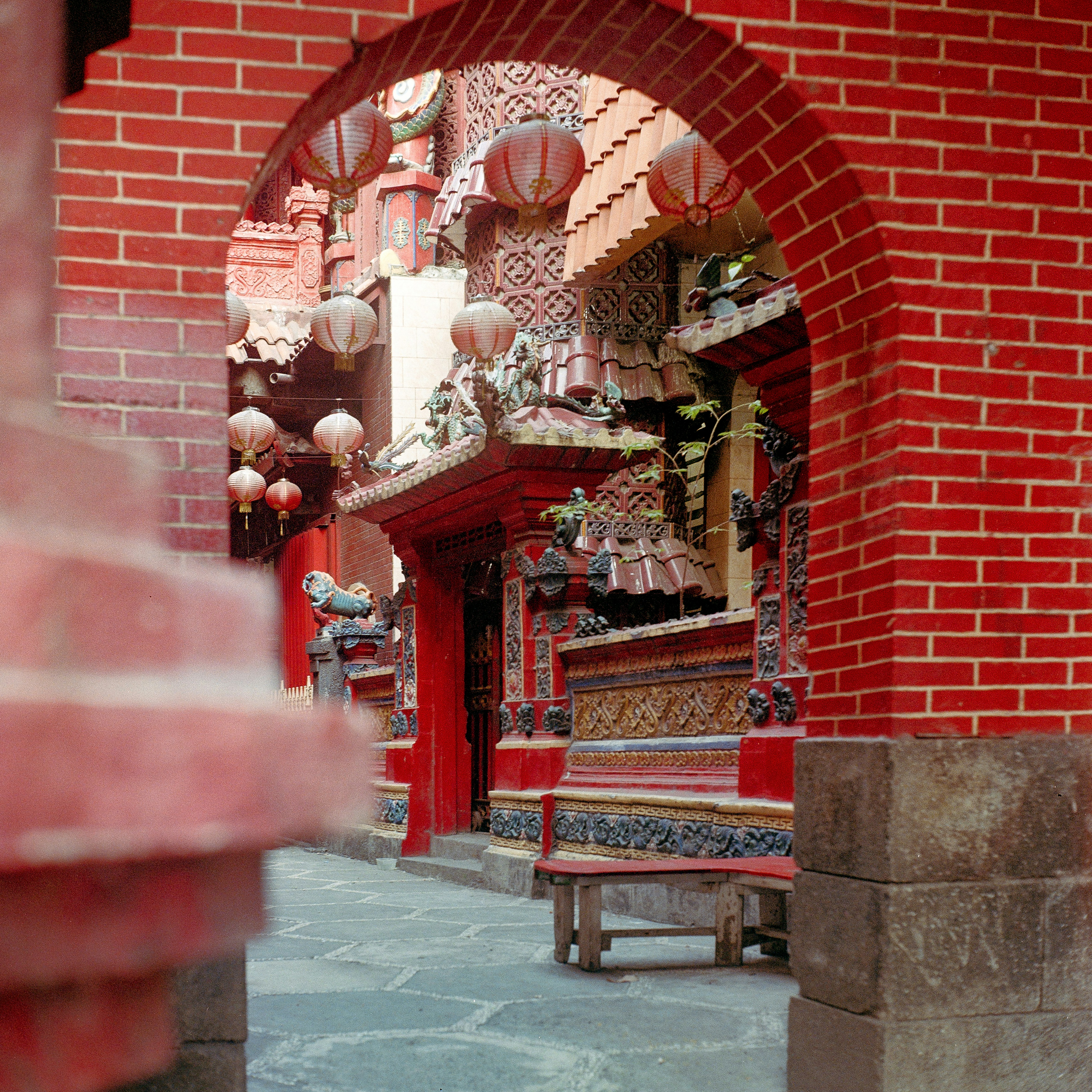 Red Archway Sanctuary: Lanterns and carved timber in a Chinese temple courtyard