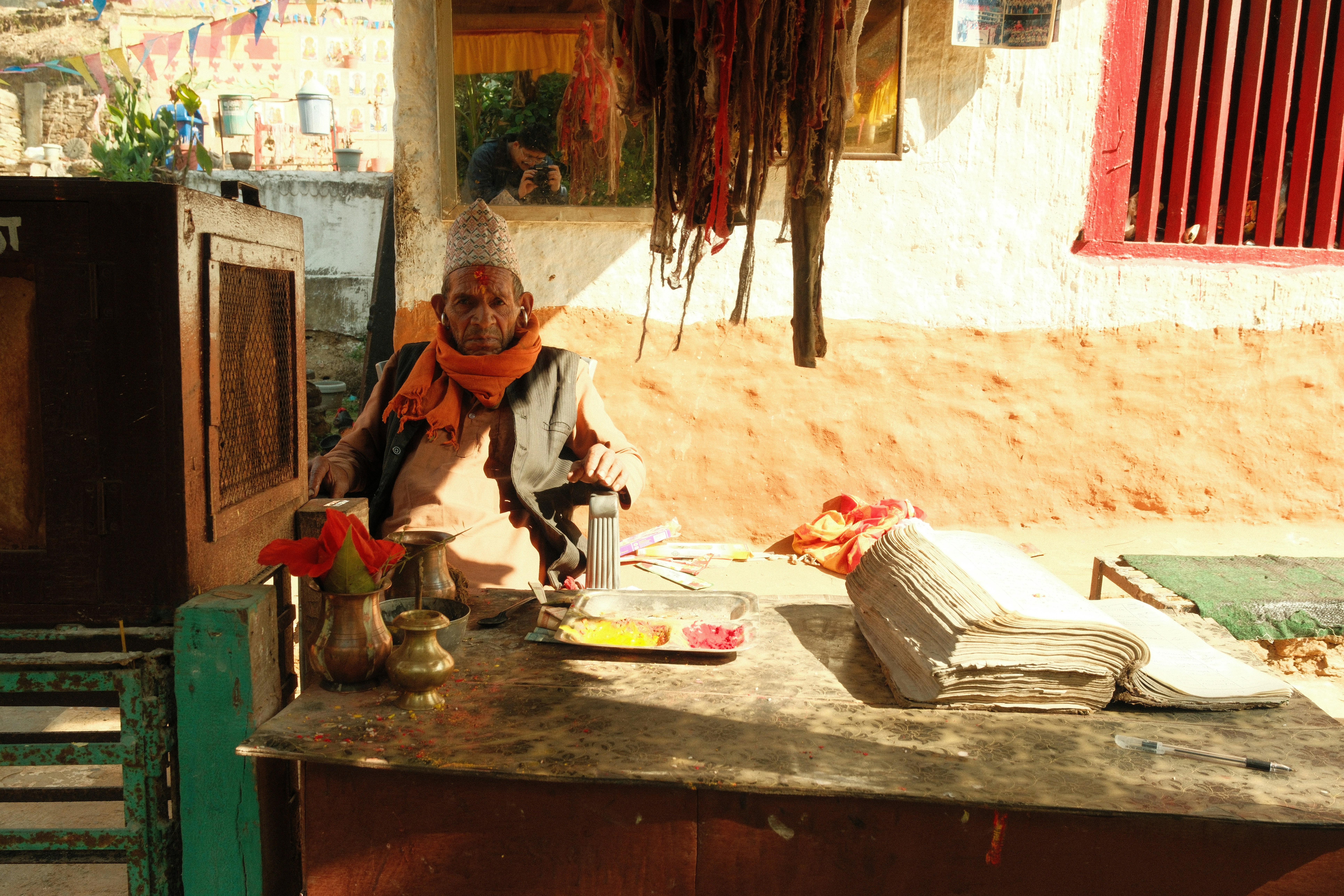 Vendor at the Sunlit Stall: Quiet Moment in an Indian Tekri