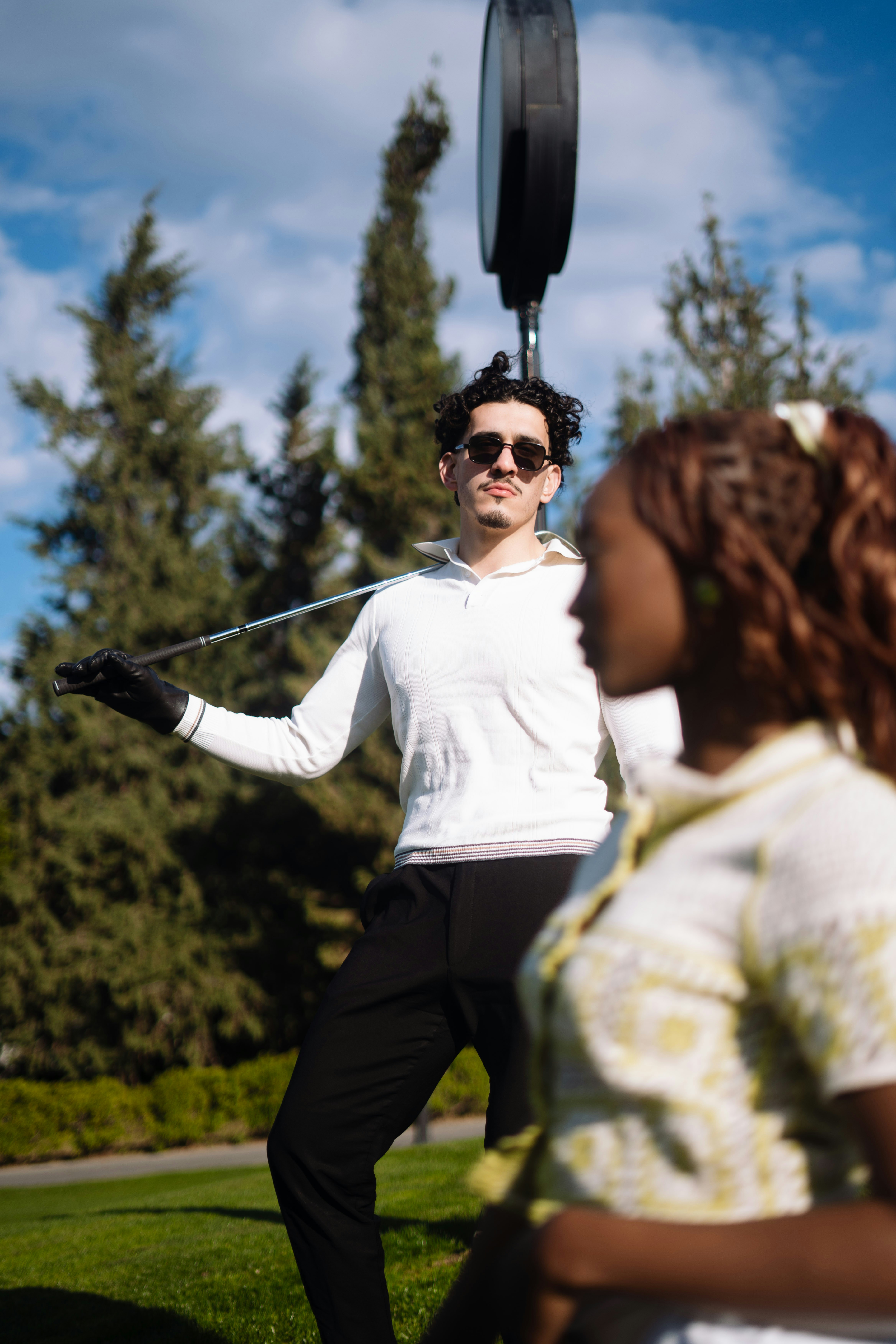Swinging Spotlight: A Surreal Golf Paradox in the Park