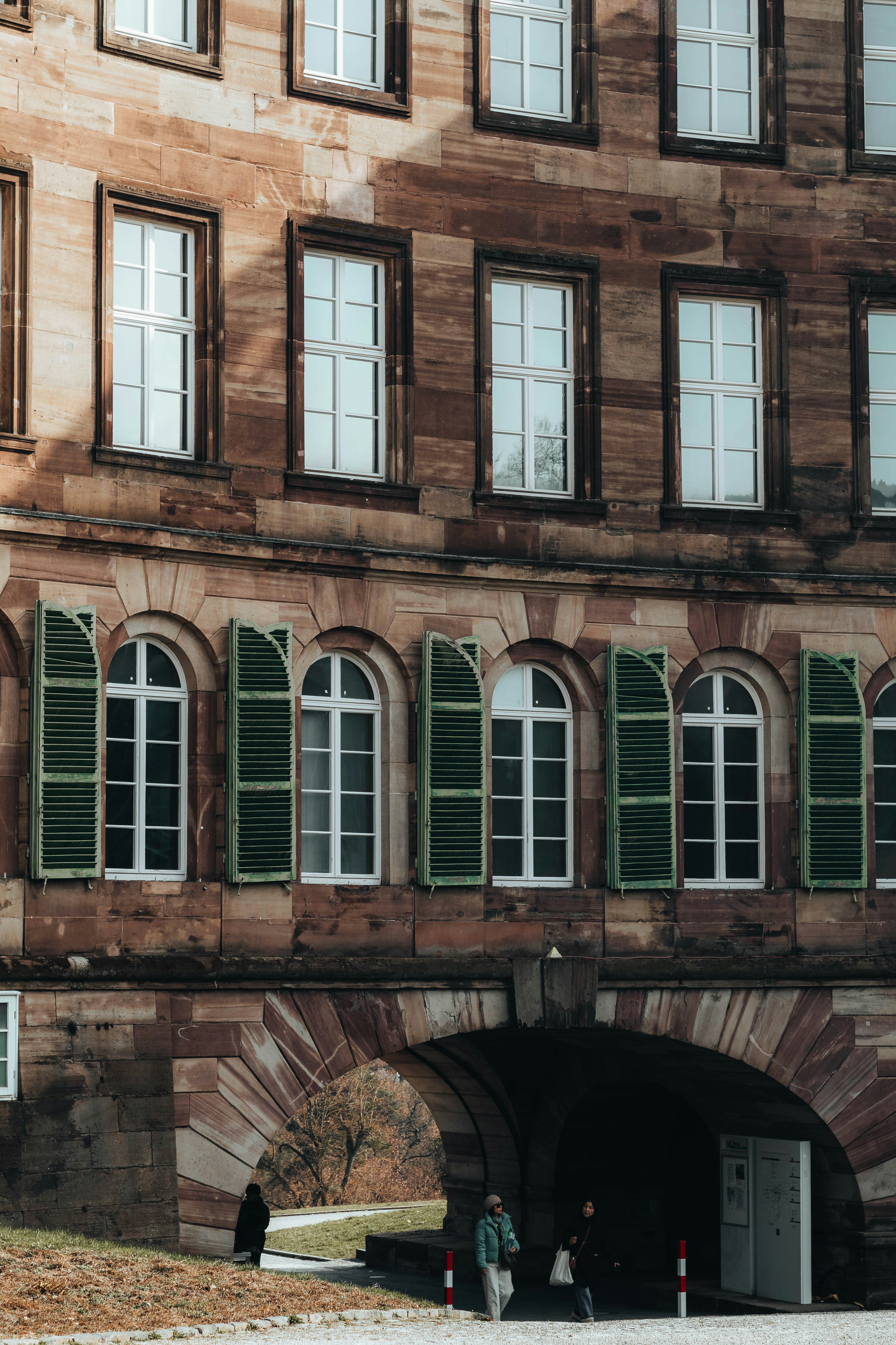 Archways and Echoes: A City Facade in the Afternoon Light