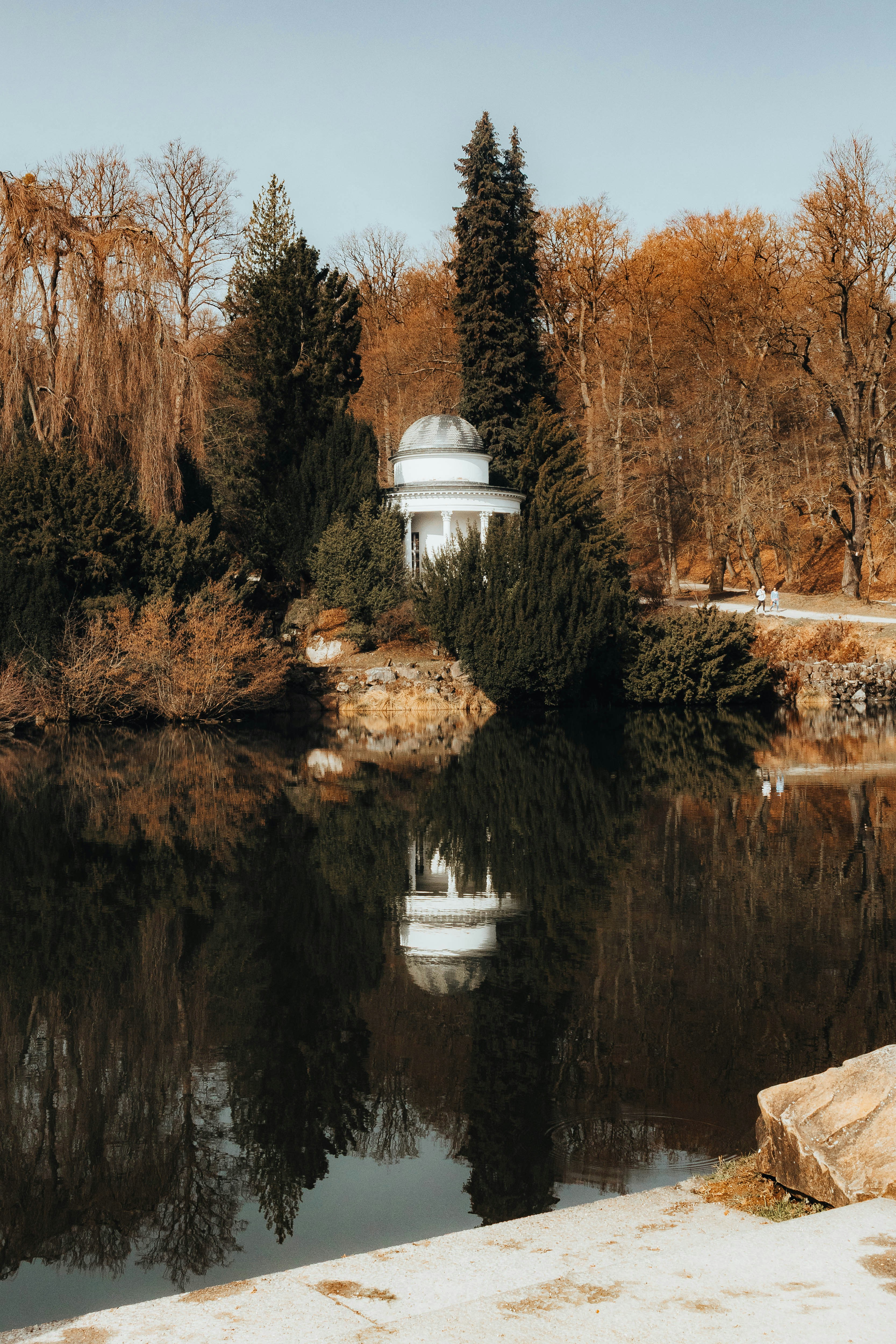 Atrium in Autumn: White Pavilions by the Silent Lake