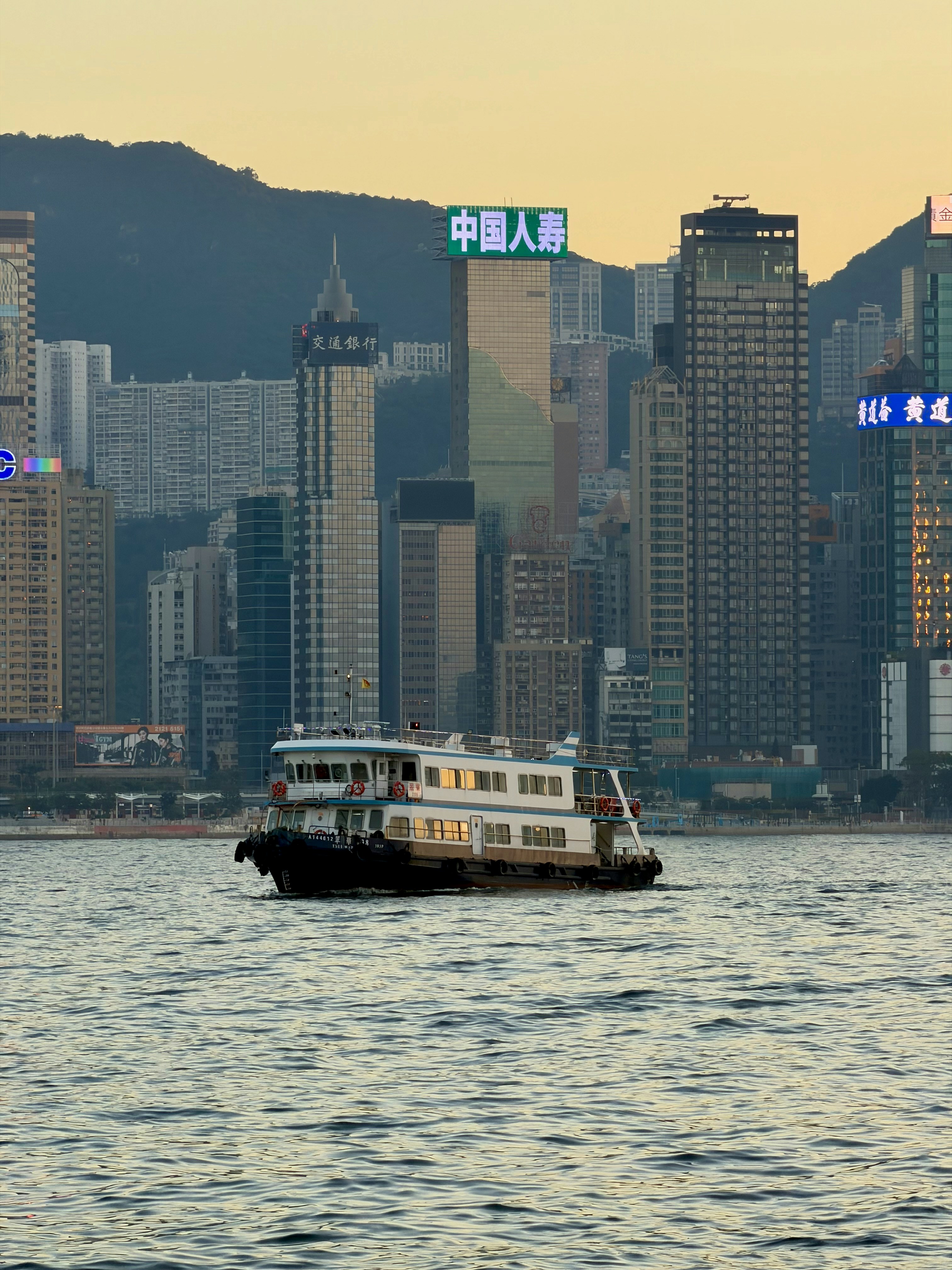 Harbor Ferry Against a Neon City Skyline at Dusk