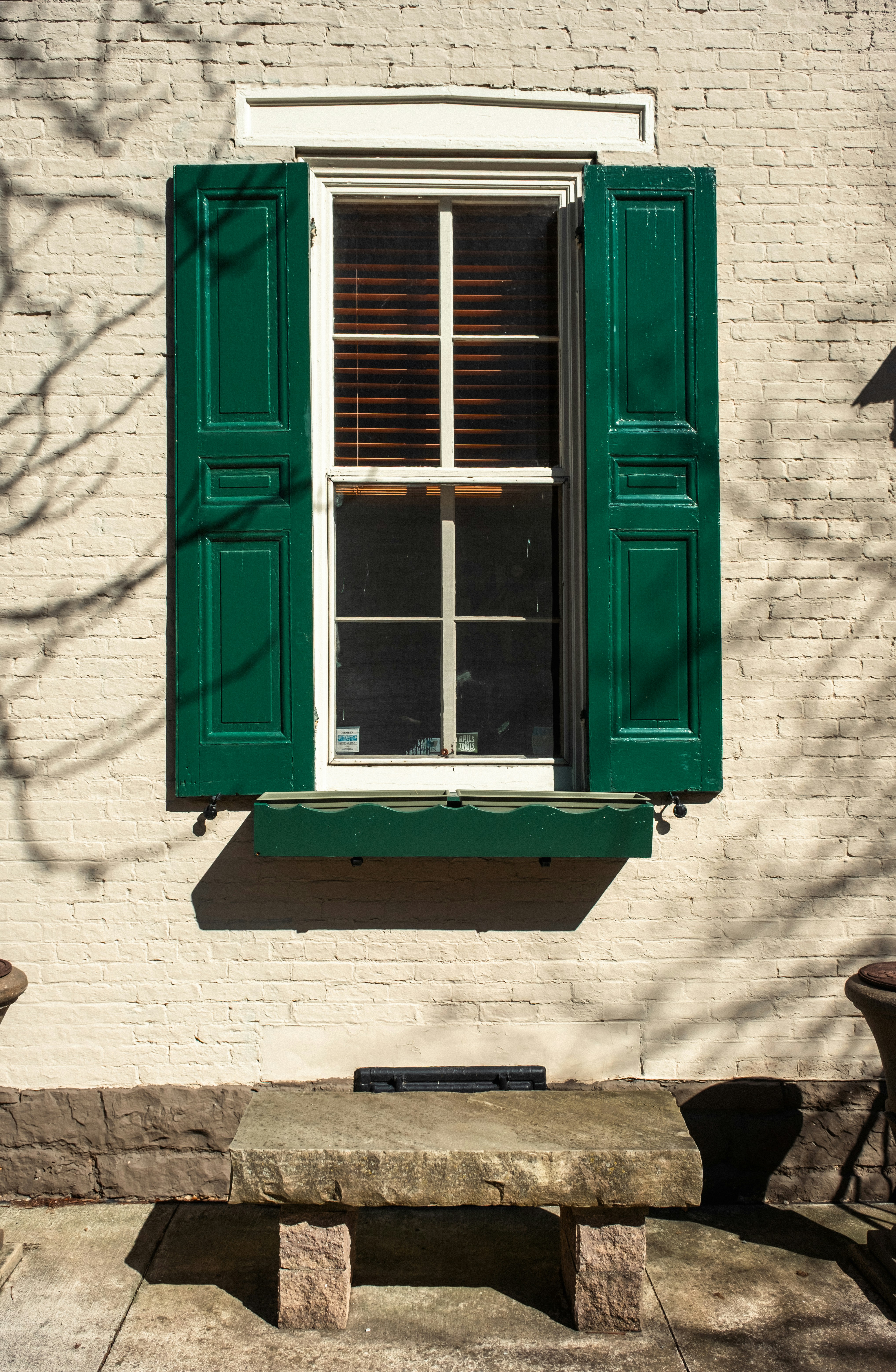 Green Window, Sunlit Brick: A Quiet Street Facade