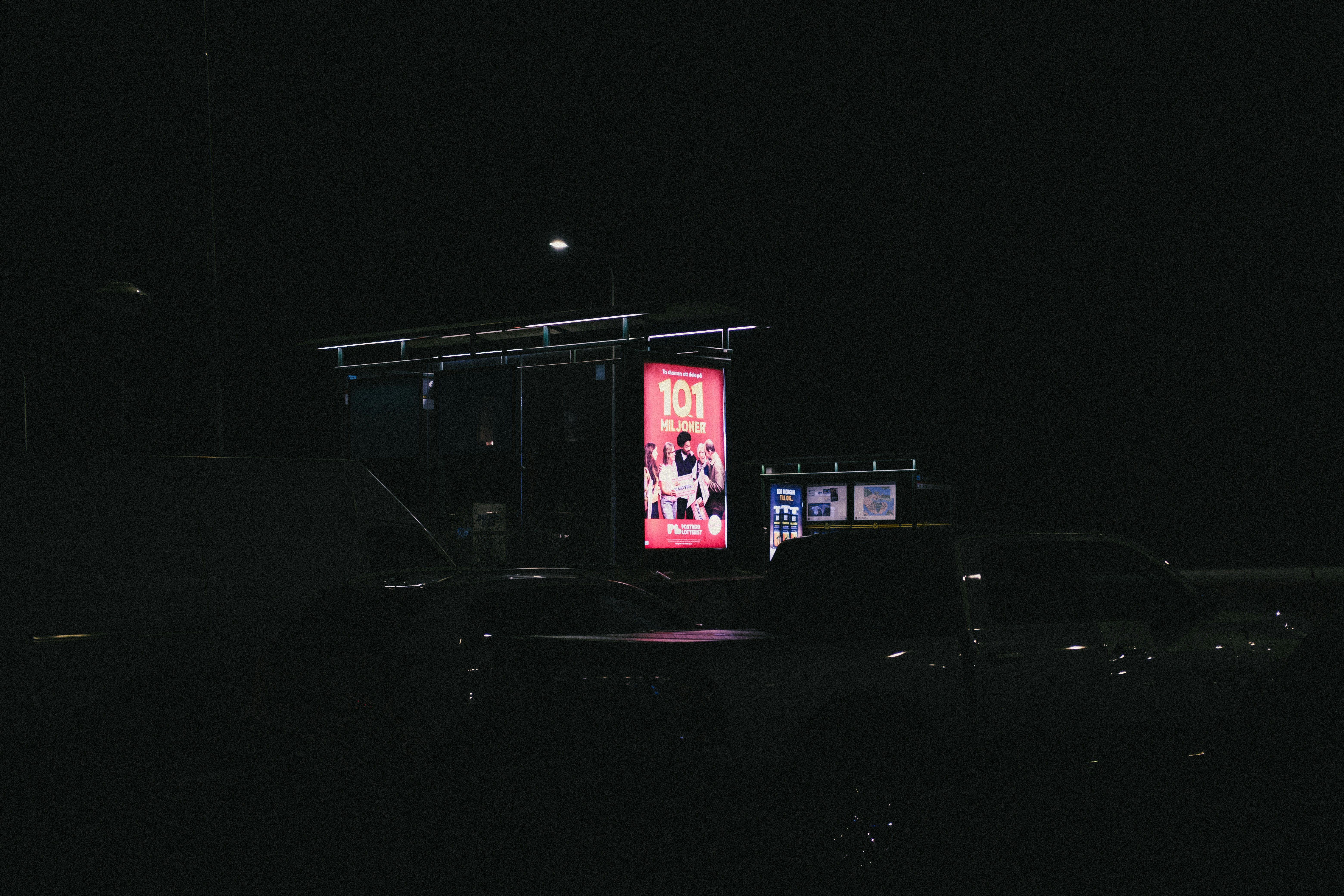 Night Drive Billboard Under Low Light: A Quiet Parking Lot Scene