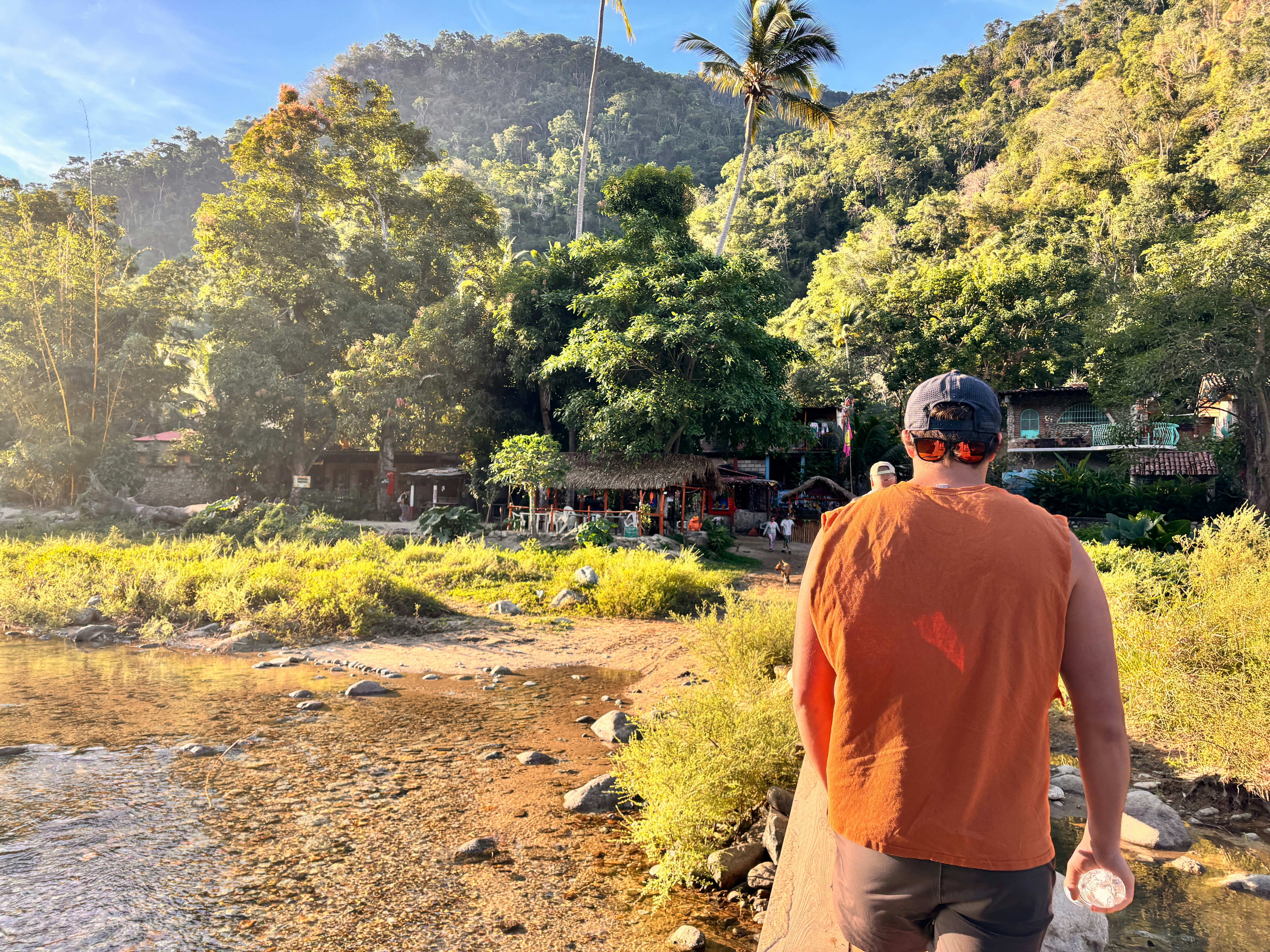 Backlit Traveler at the Riverside Village