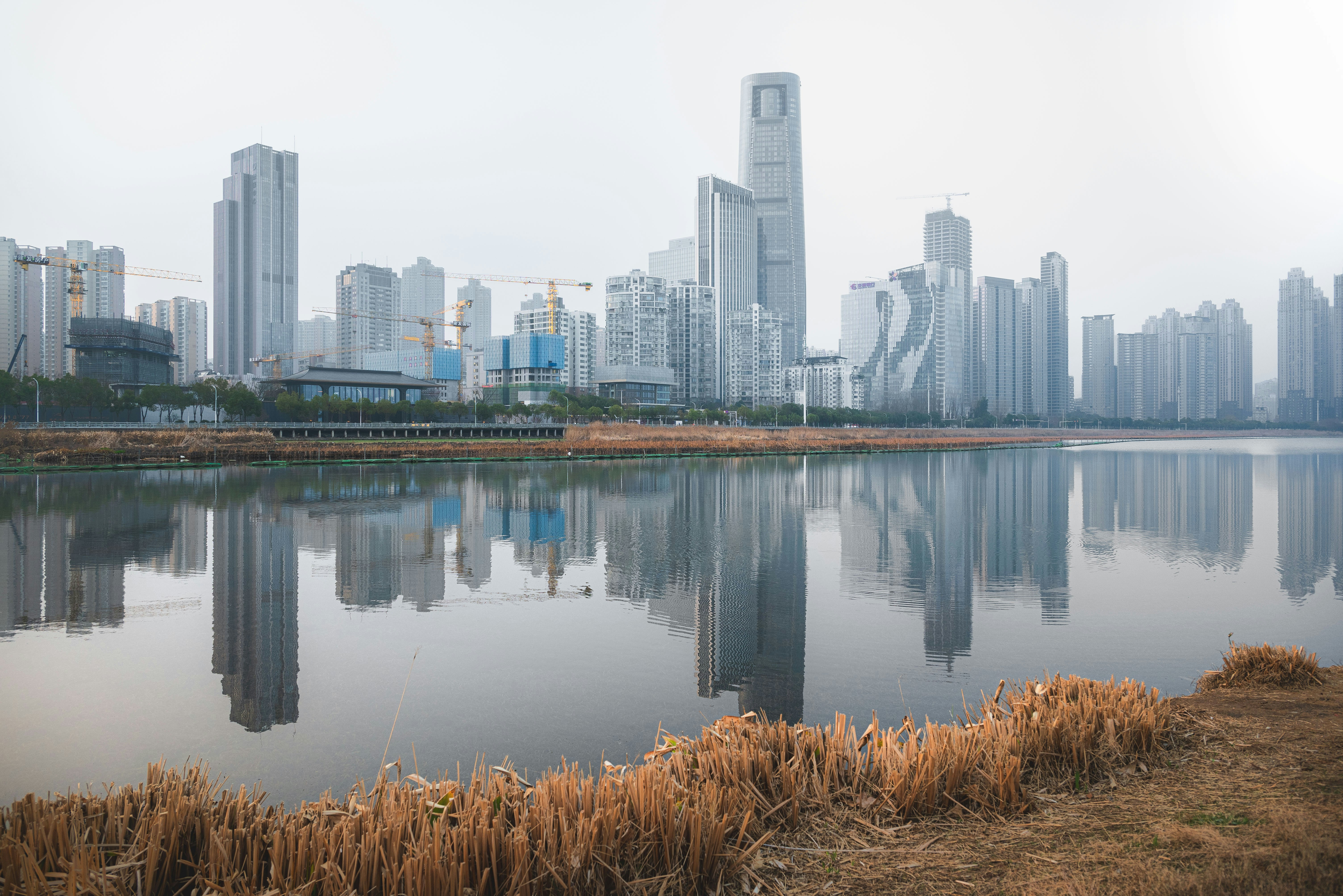 Urban Mirror: skyline and riverbank collide in still water
