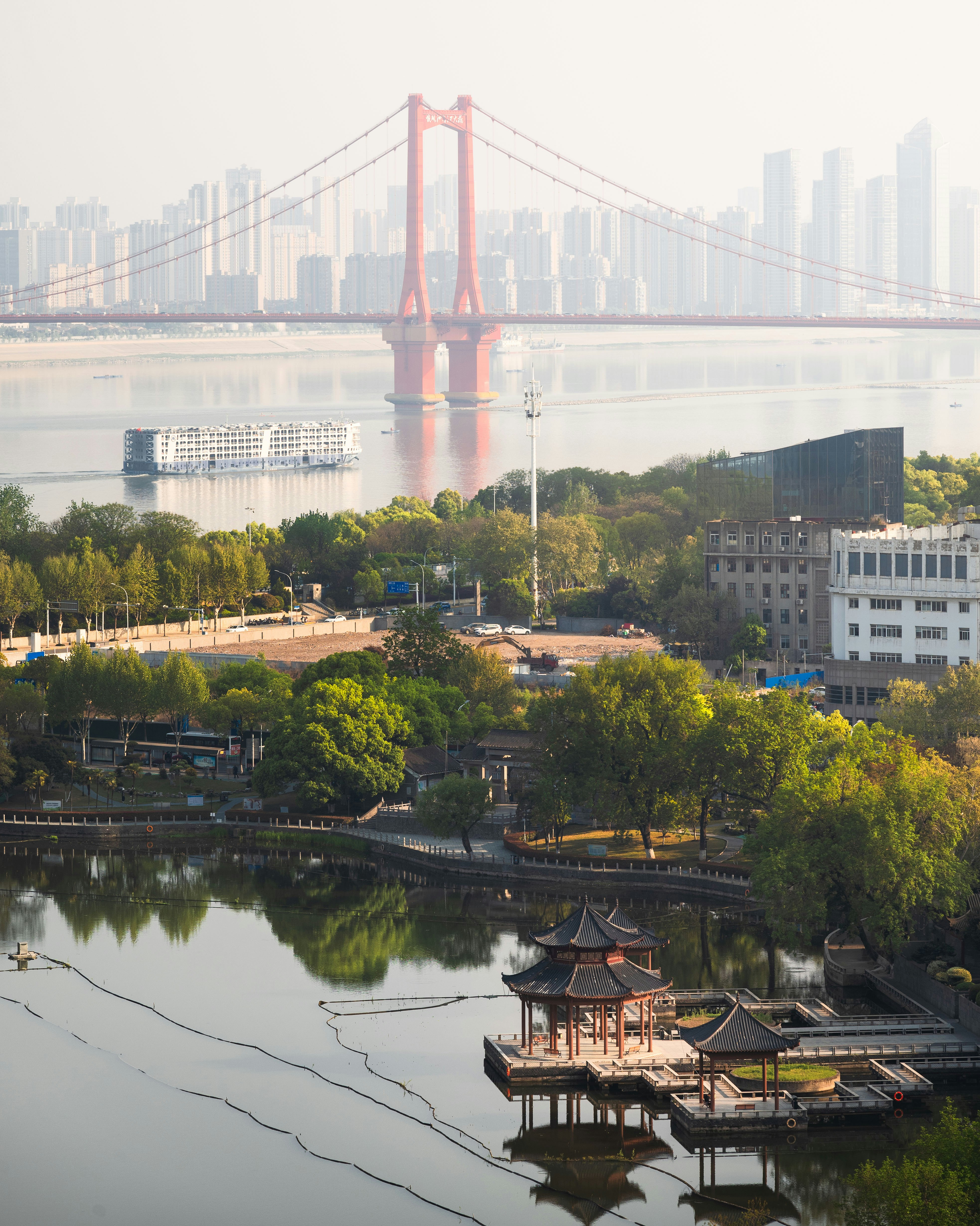Red Bridge Over Quiet Waters: A Multi-Laceted Cityscape