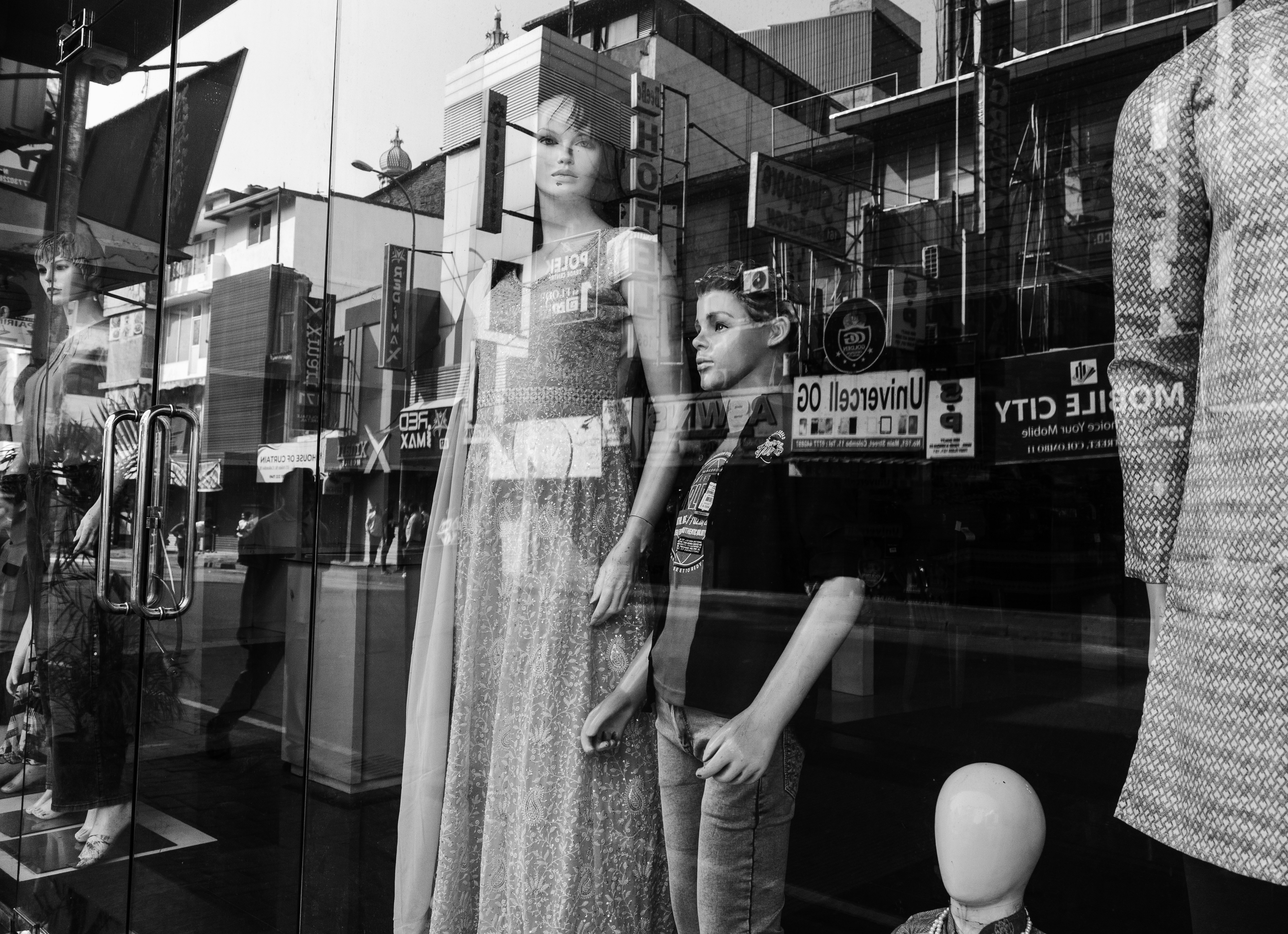 Reflections of Fashion: Glass storefronts and mannequins in urban monochrome