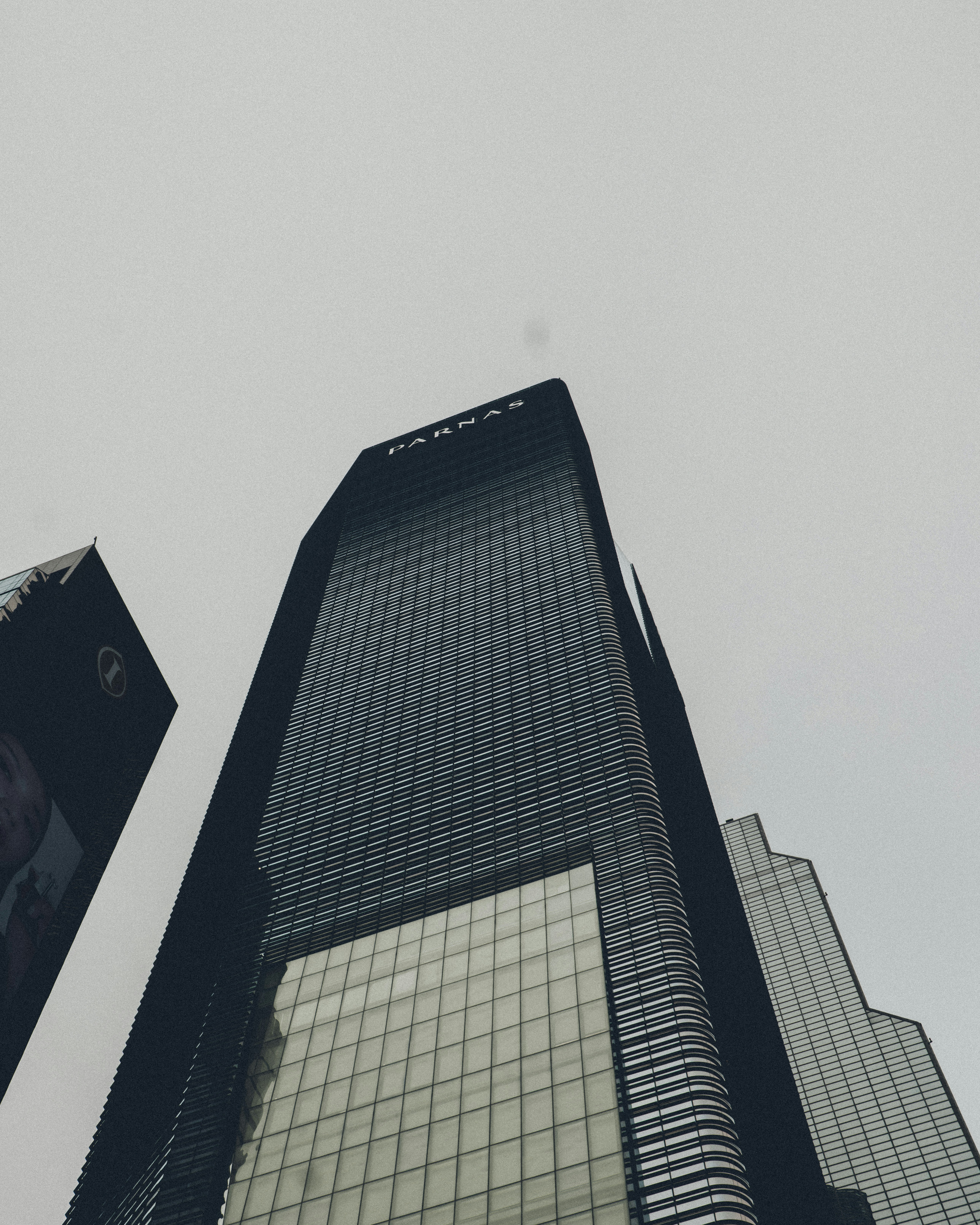 Skyscraper Portrait: A Night of Geometric Facades Amid Quiet Sky