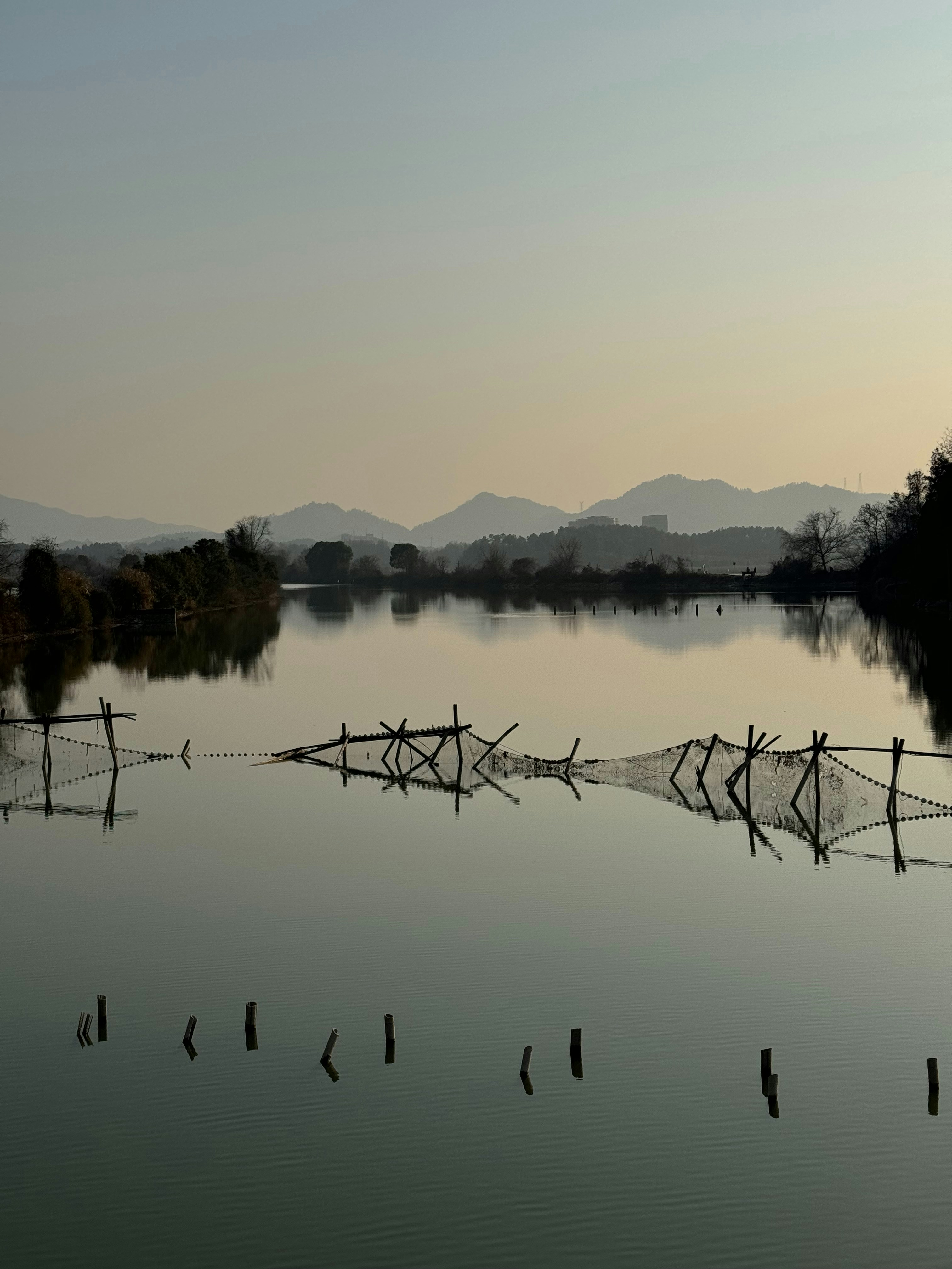 Silent Spillway: A Mirrored River Beneath Mountain Silhouette