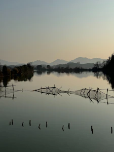 Silent Spillway: A Mirrored River Beneath Mountain Silhouette