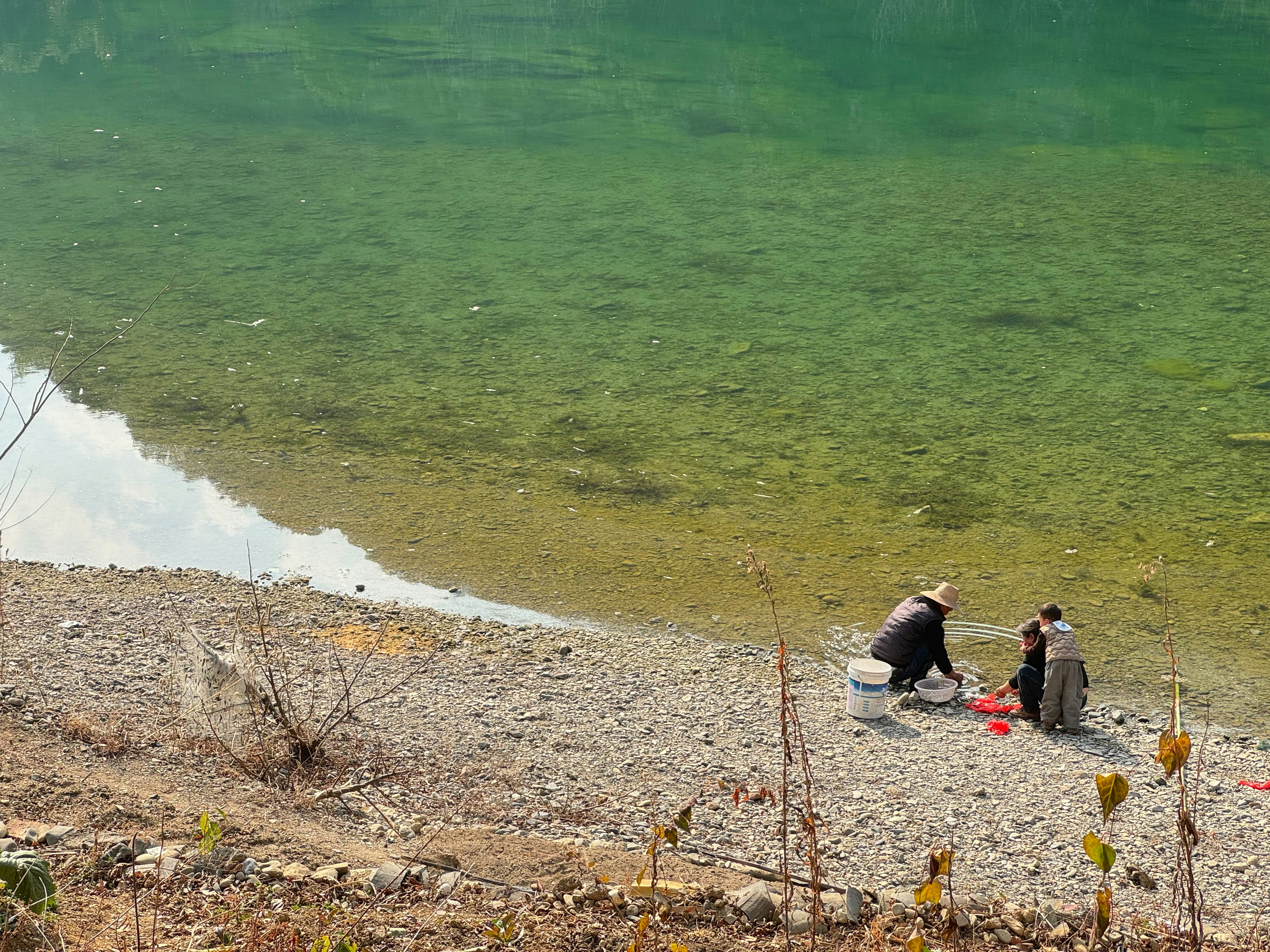 Quiet Shoreline: Friends Wash, Gather, and Share by Clear Water