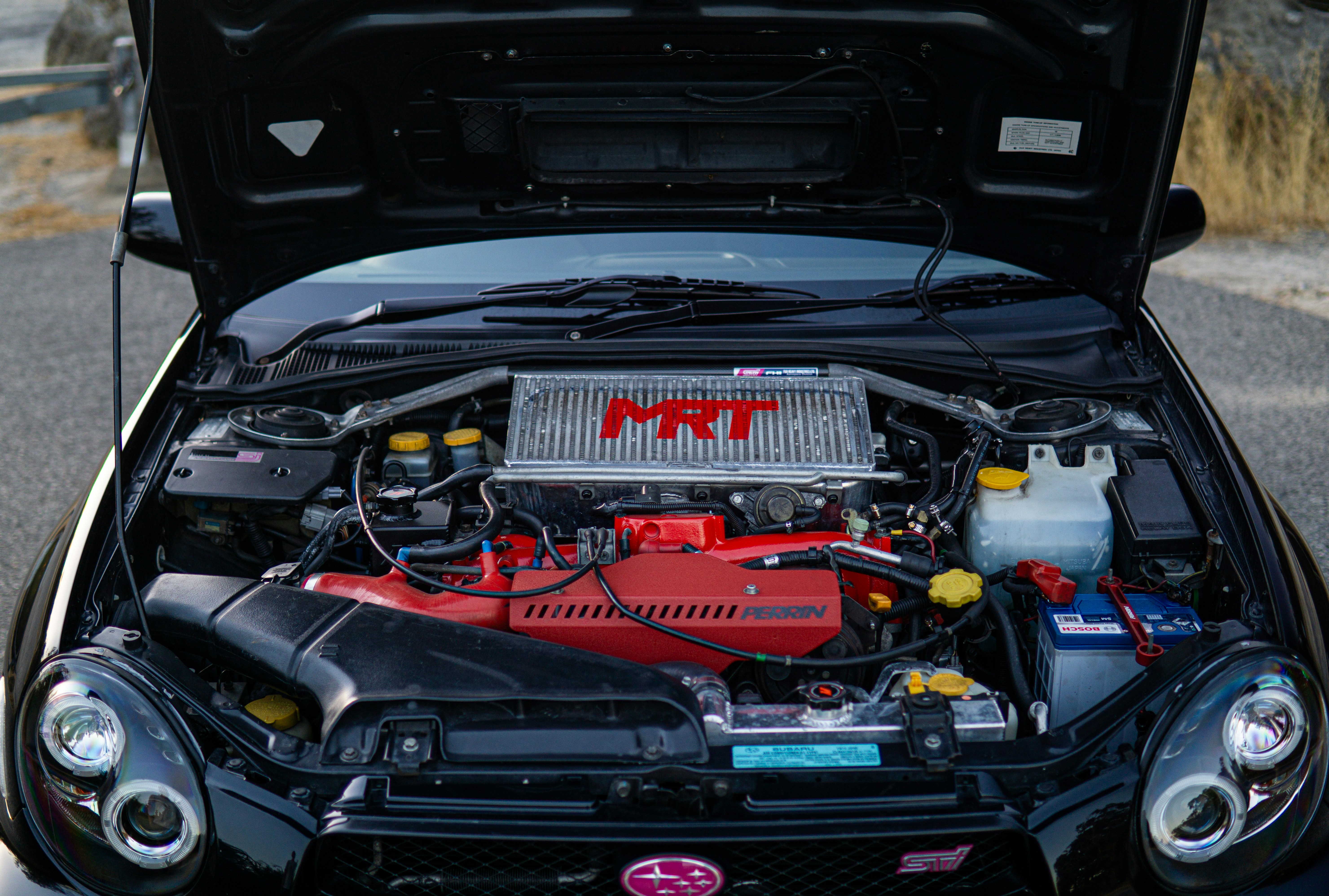 Red Accents Under the Hood: A Close-Up of a Tuned Engine Bay