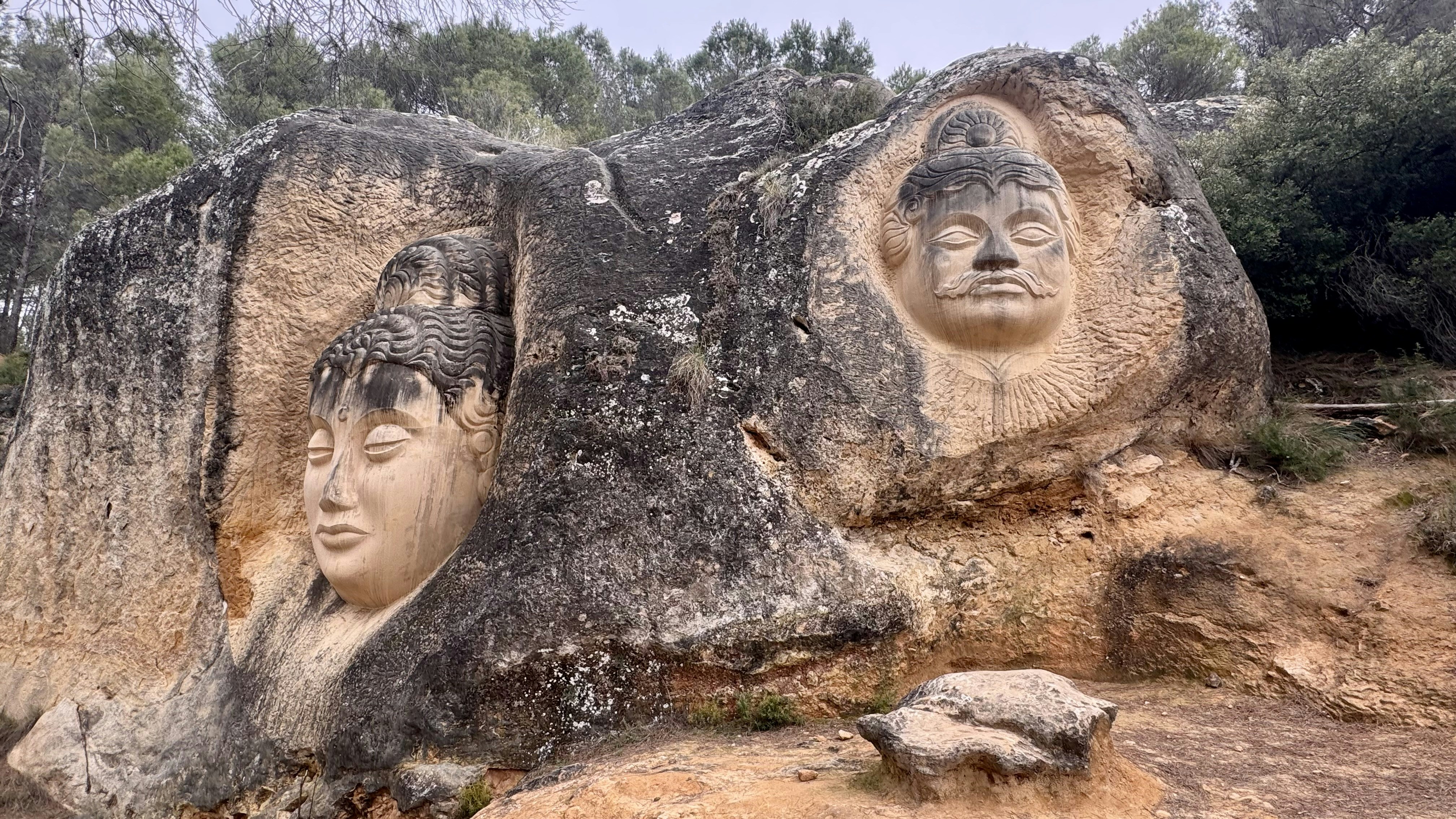 Carved Buddhas in Weathered Rock: Quiet Sentinel of the Hillside