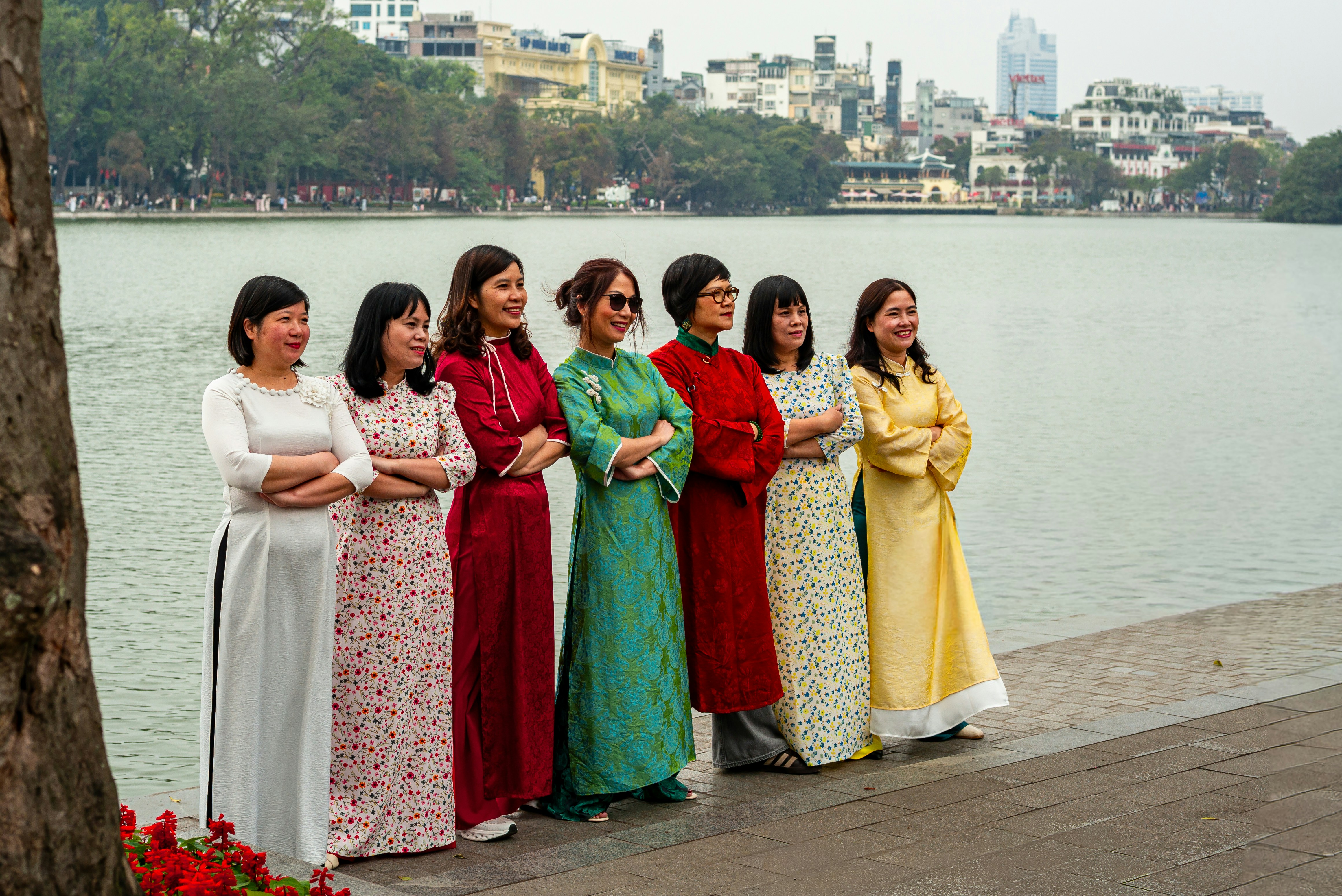 Seven Silhouettes in Colorful Ao Dai by the River
