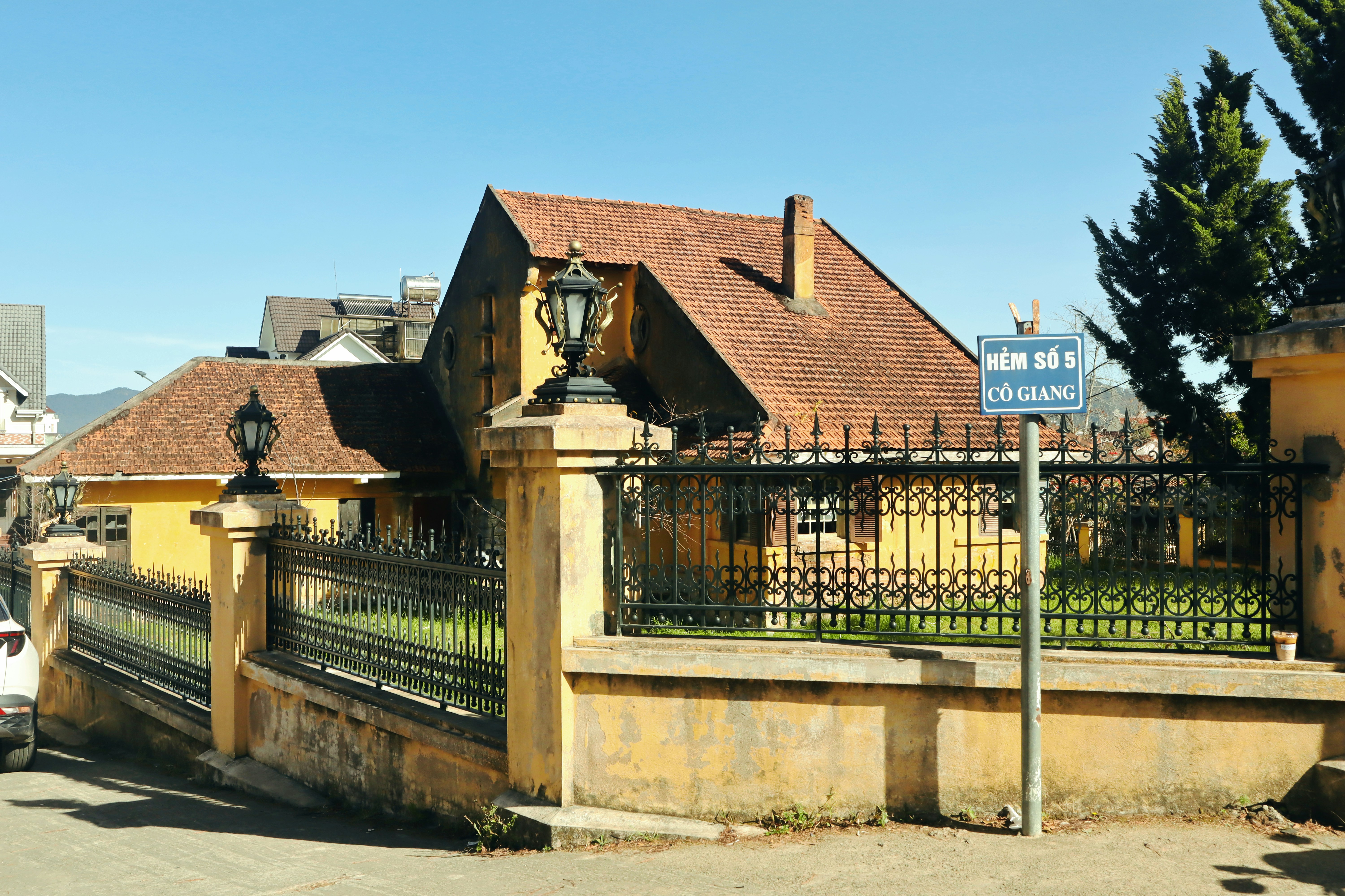 Stonegate Villa with Wrought-Iron Fence and Signpost